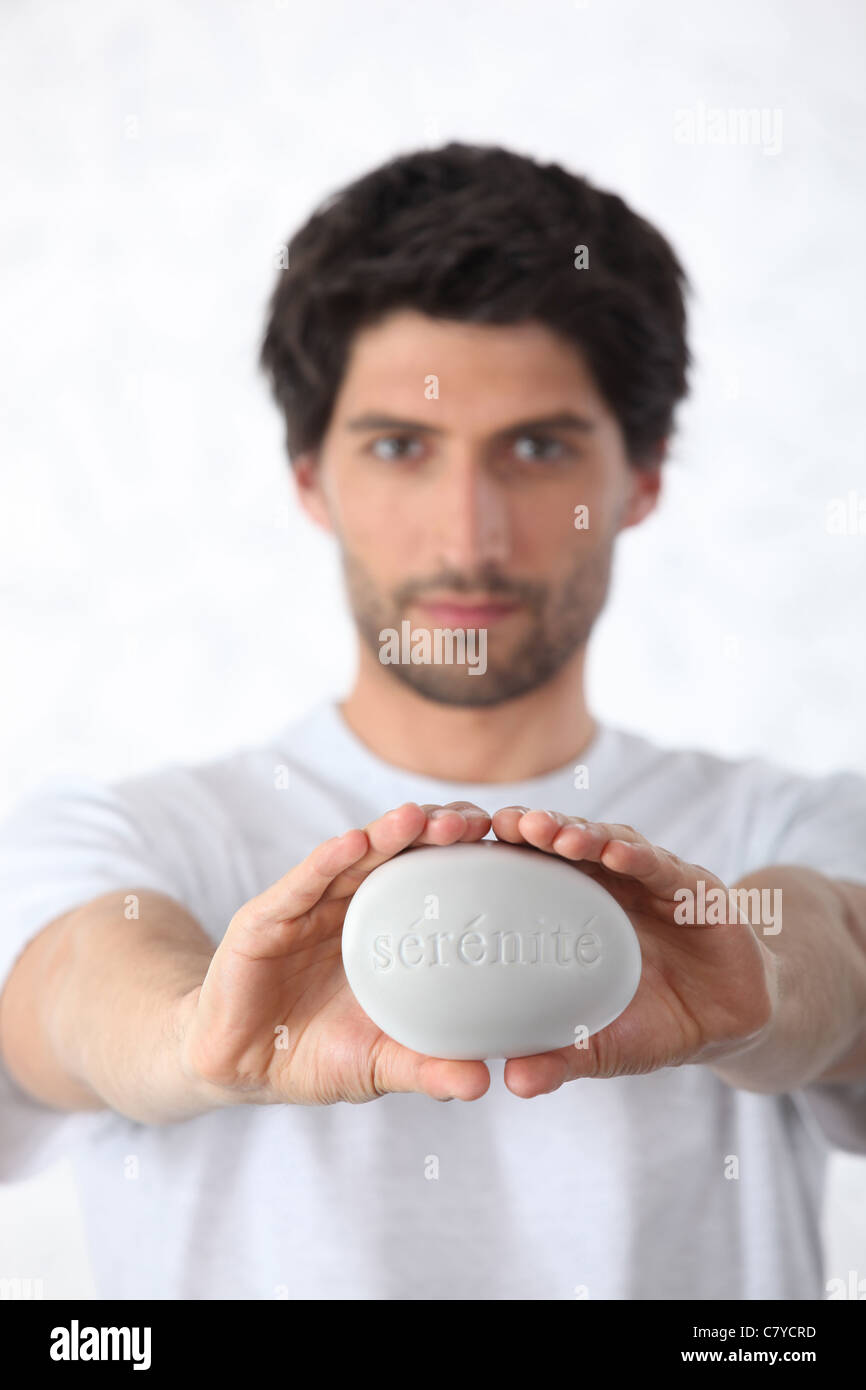 Man holding a bar of soap Stock Photo - Alamy