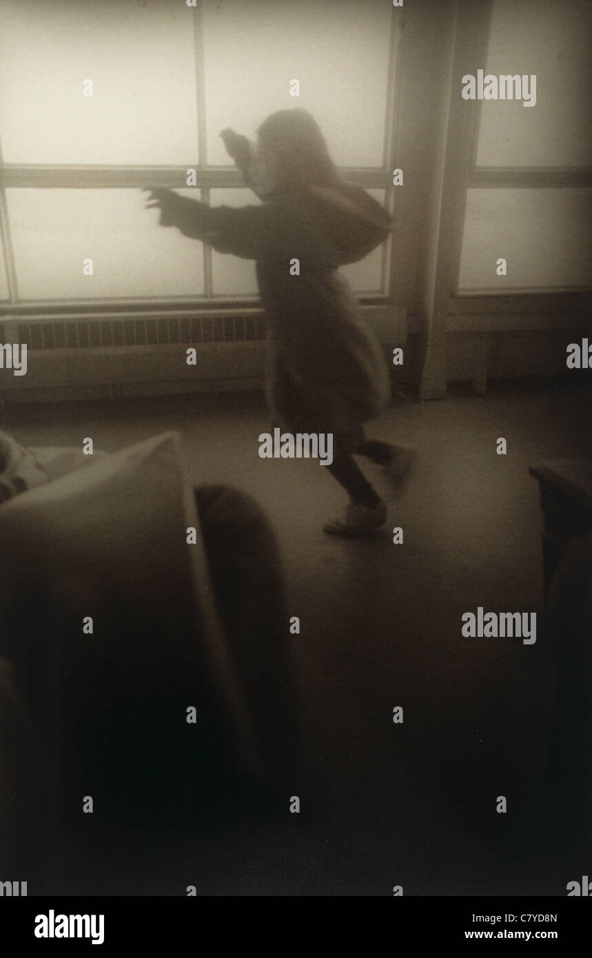 small girl running indoors beside window Stock Photo - Alamy