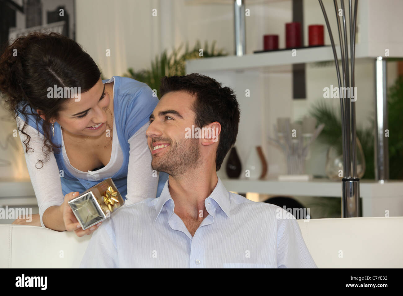 Woman giving gift to boyfriend Stock Photo - Alamy