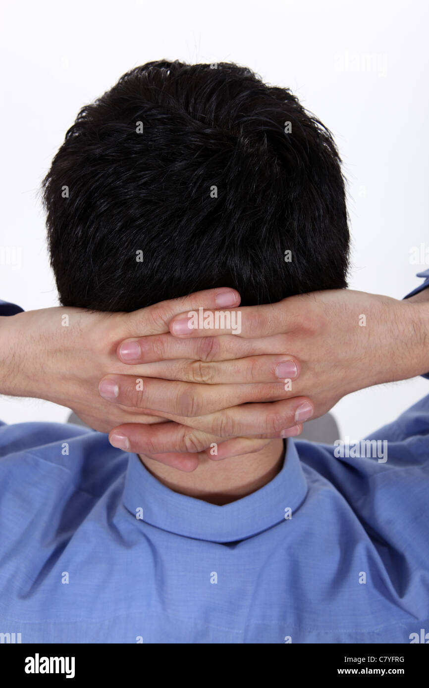 man holding his hands on his neck Stock Photo - Alamy