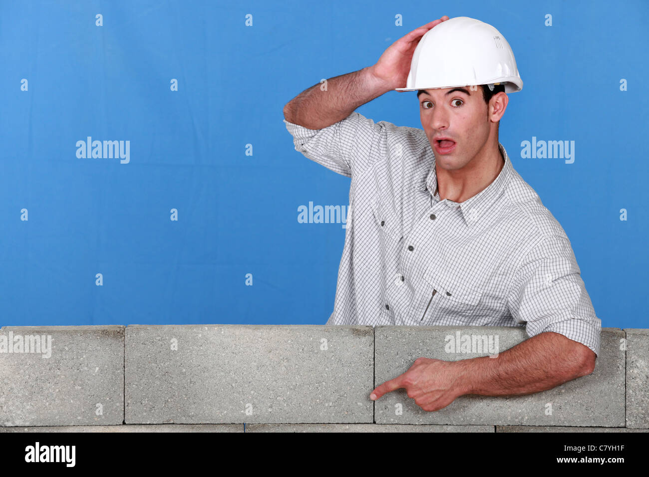 A mason pointing at a wall Stock Photo - Alamy