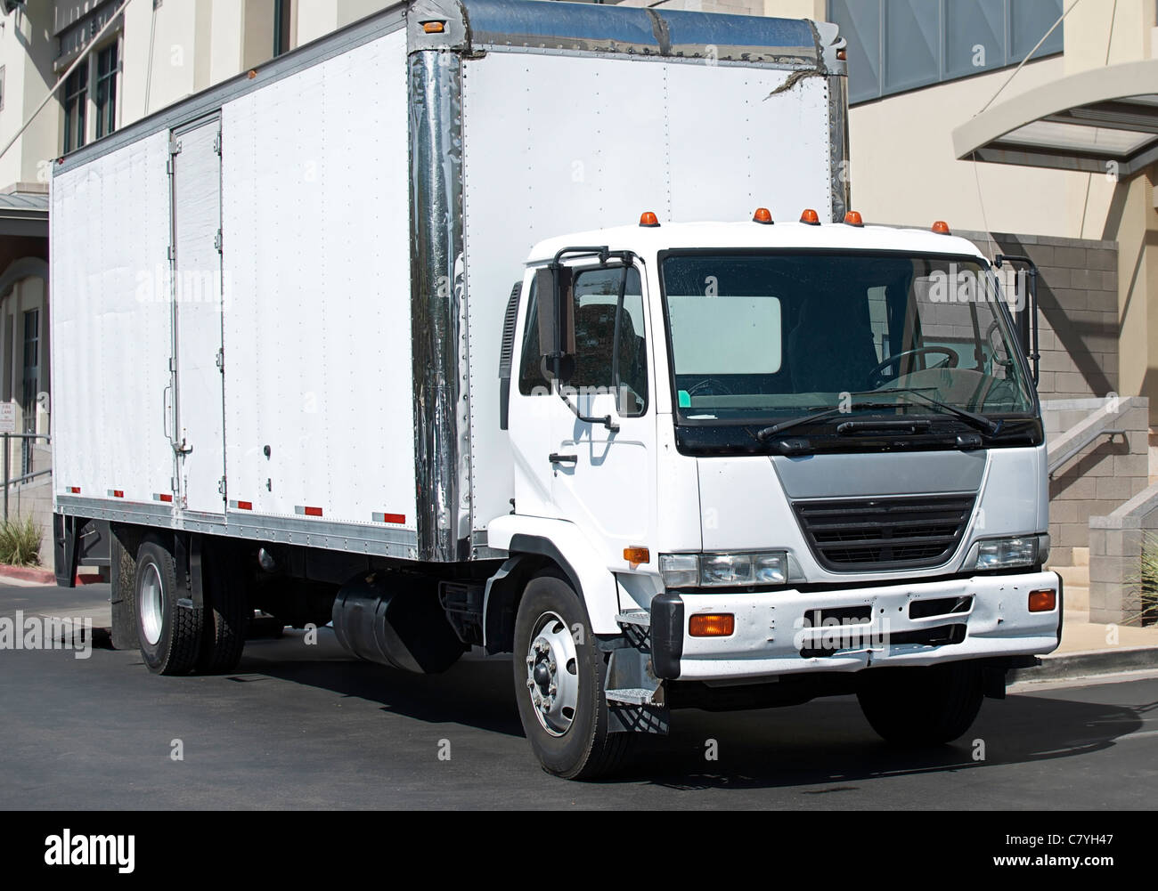 White van truck delivery supplies goods to store Stock Photo - Alamy
