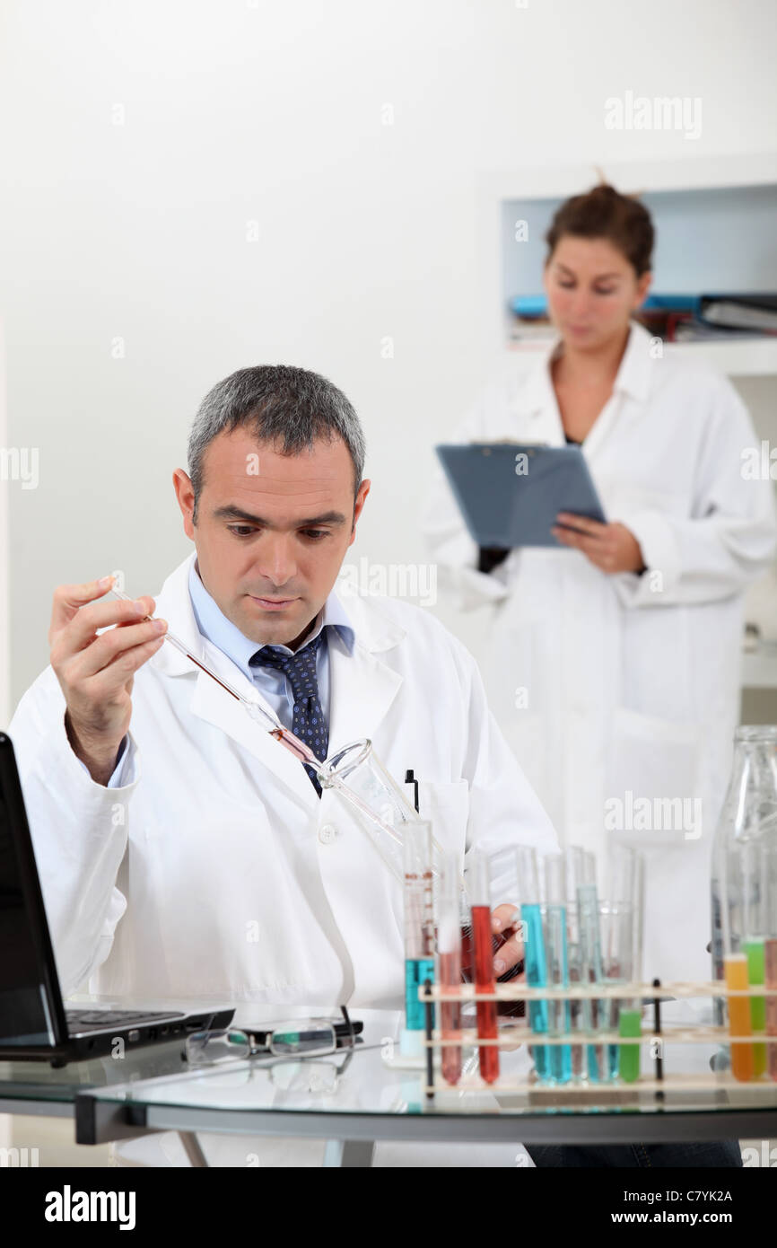 a scientist using test tubes Stock Photo - Alamy