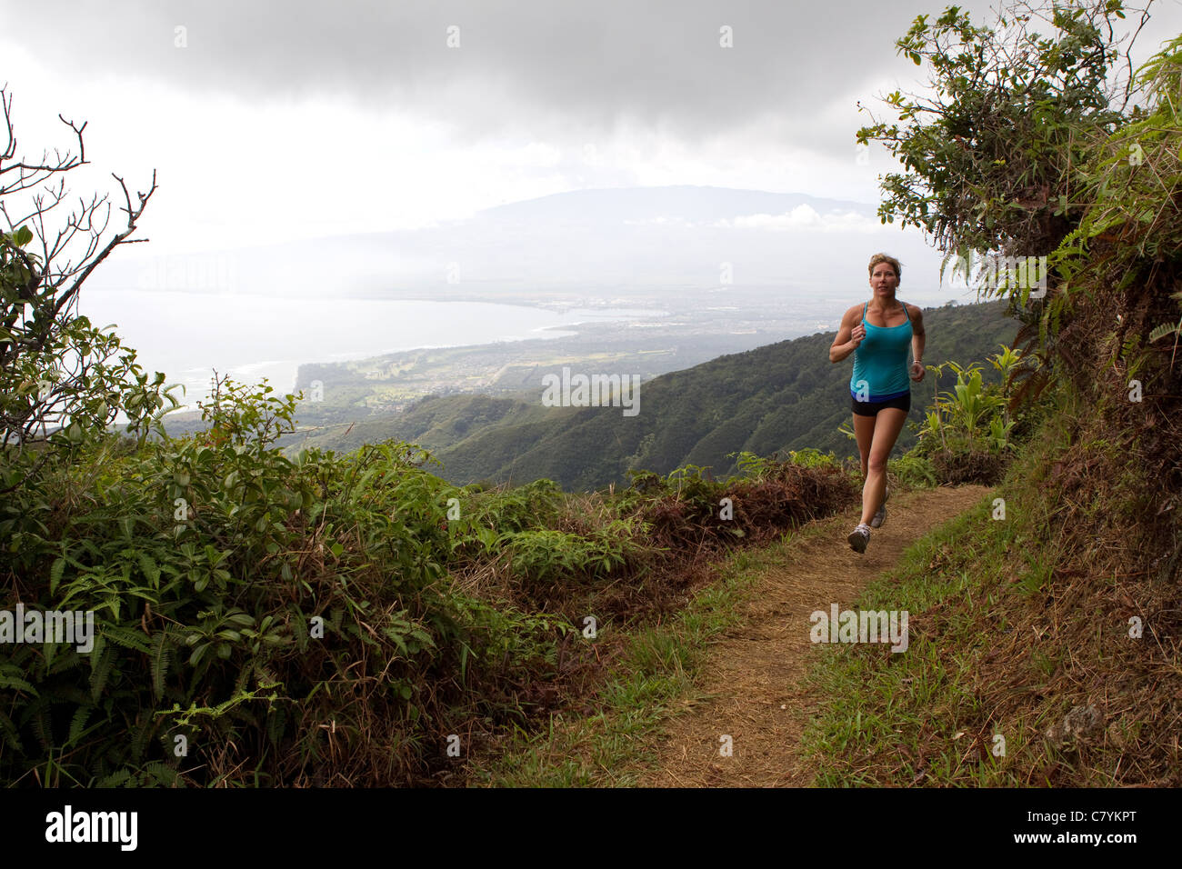 A woman running on the Waihee Ridge Trail on Maui Stock Photo - Alamy