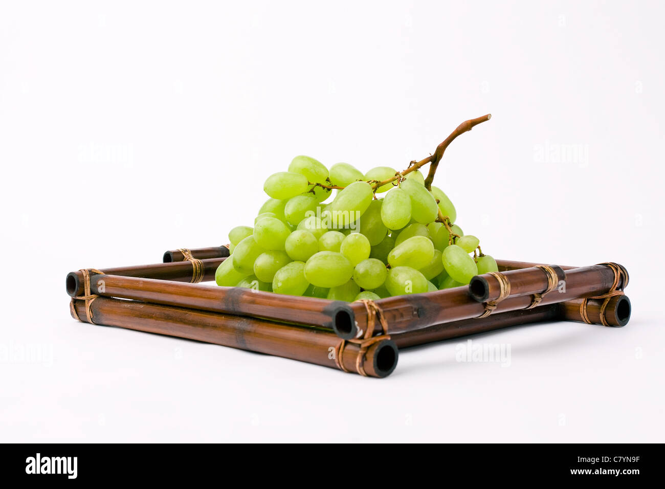 fresh grapes on the wooden / bamboo tray on white background Stock ...