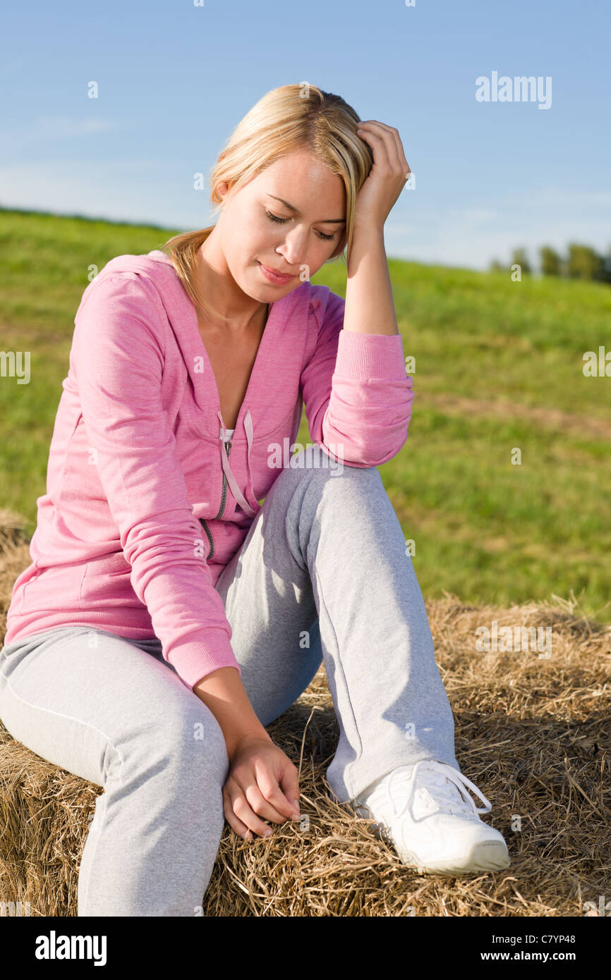 Portrait of sportive young woman relax sitting on hay bales Stock Photo ...