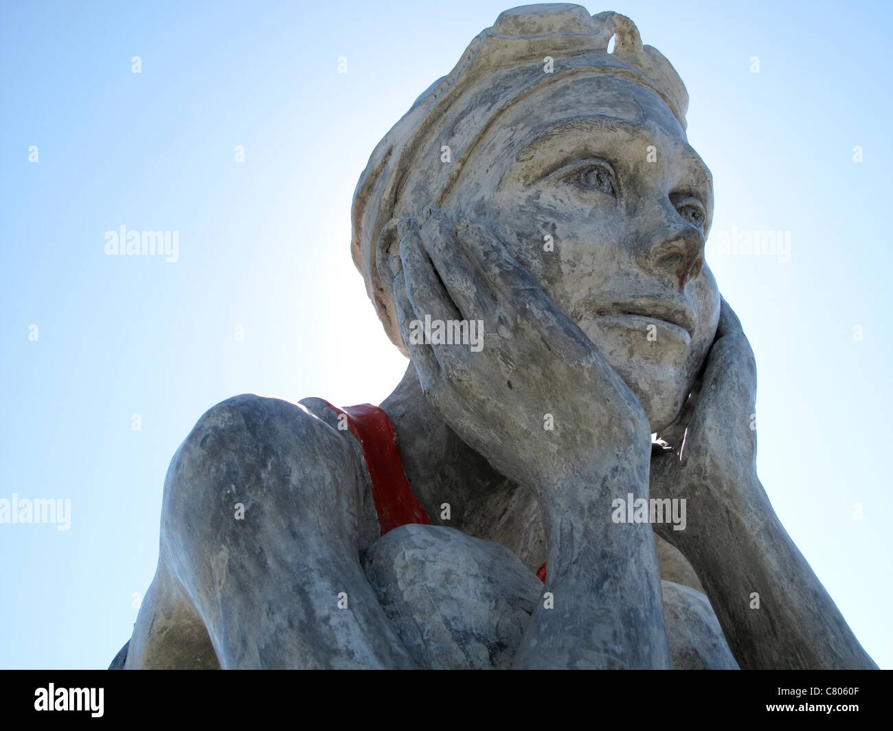 concrete stone statue female against blue sky flare sun fly sculpture ...
