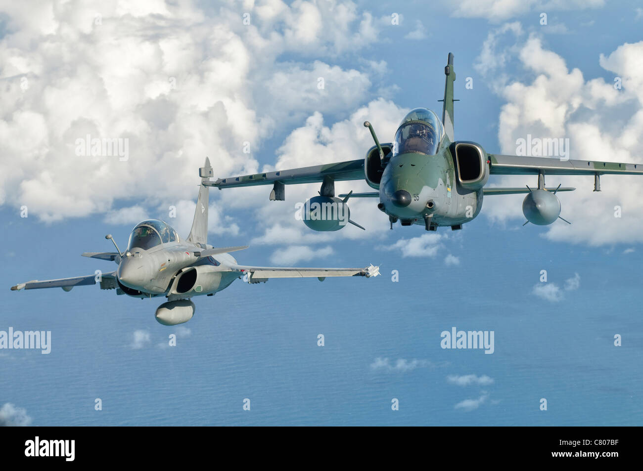 A Dassault Rafale of the French Air Force flys alongside an Embraer A ...