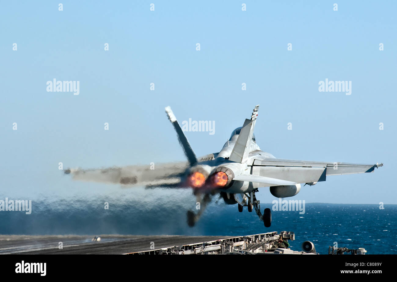 A US Navy F/A-18F Super Hornet launches from the flight deck of ...