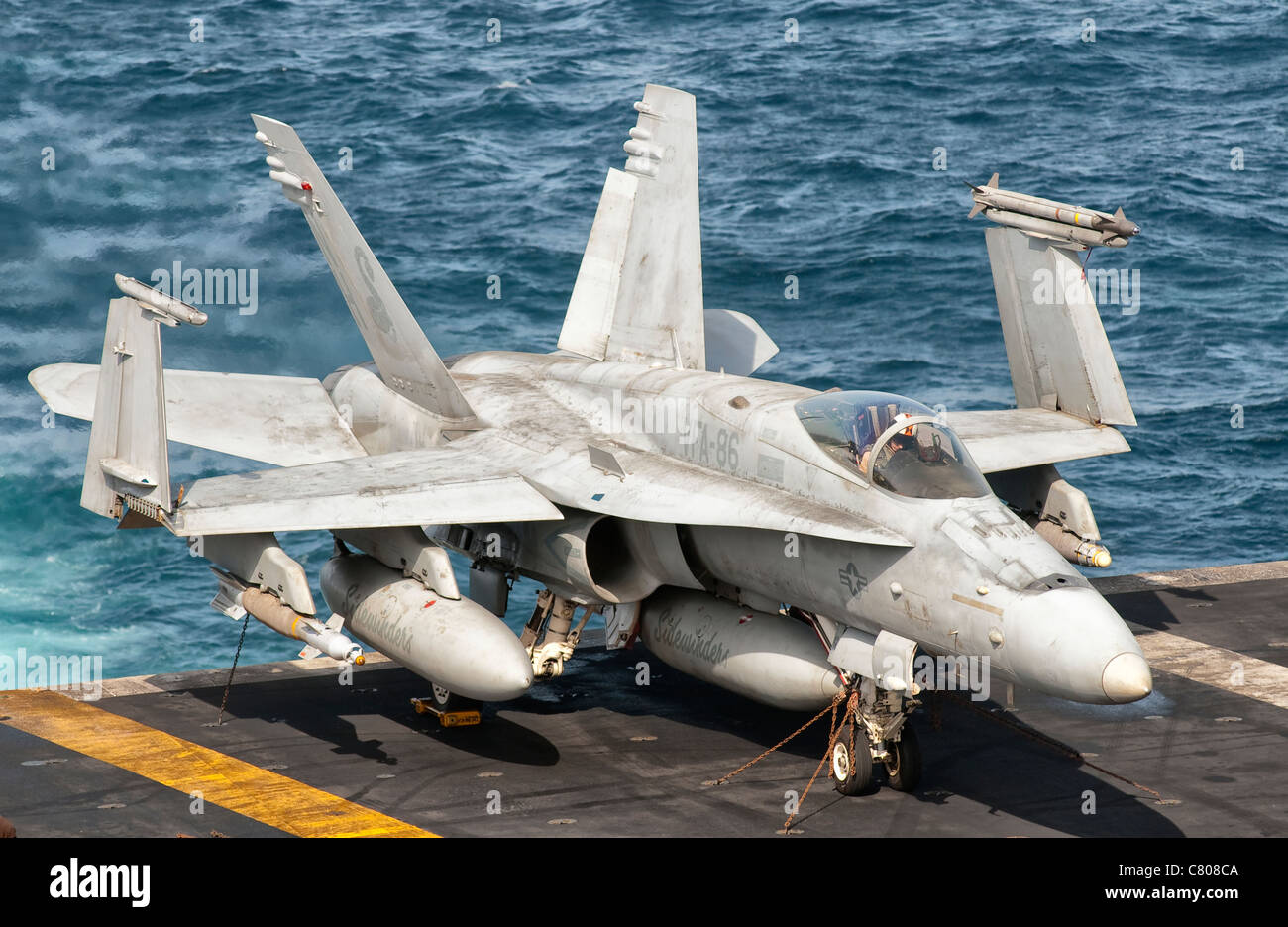 A US Navy F/A-18C Hornet tied down on the flight deck of aircraft ...