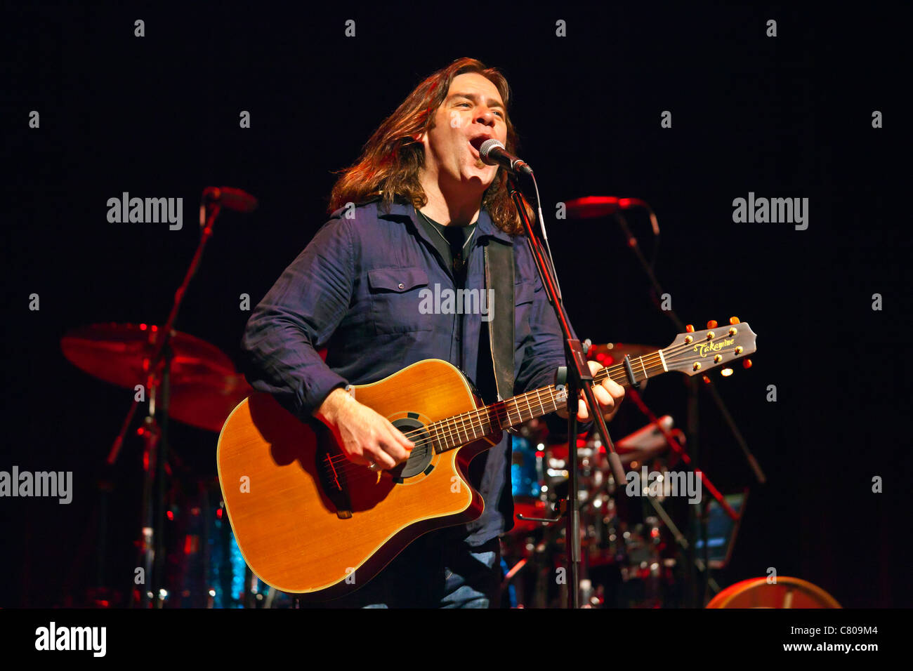Alan Doyle plays guitar for GREAT BIG SEA. a singing group from Canada ...