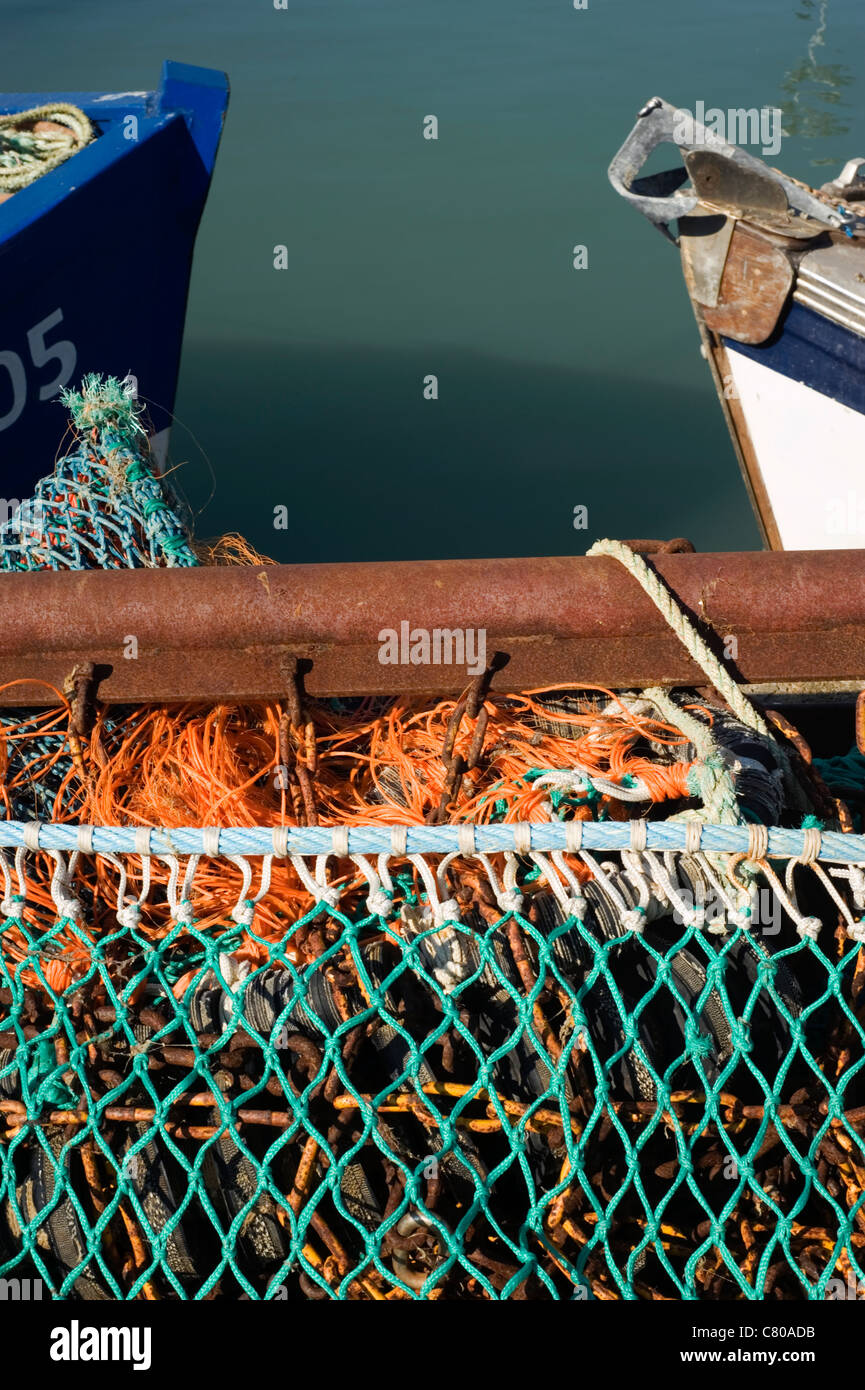 fishing nets on the ground with trawlers behind Stock Photo - Alamy