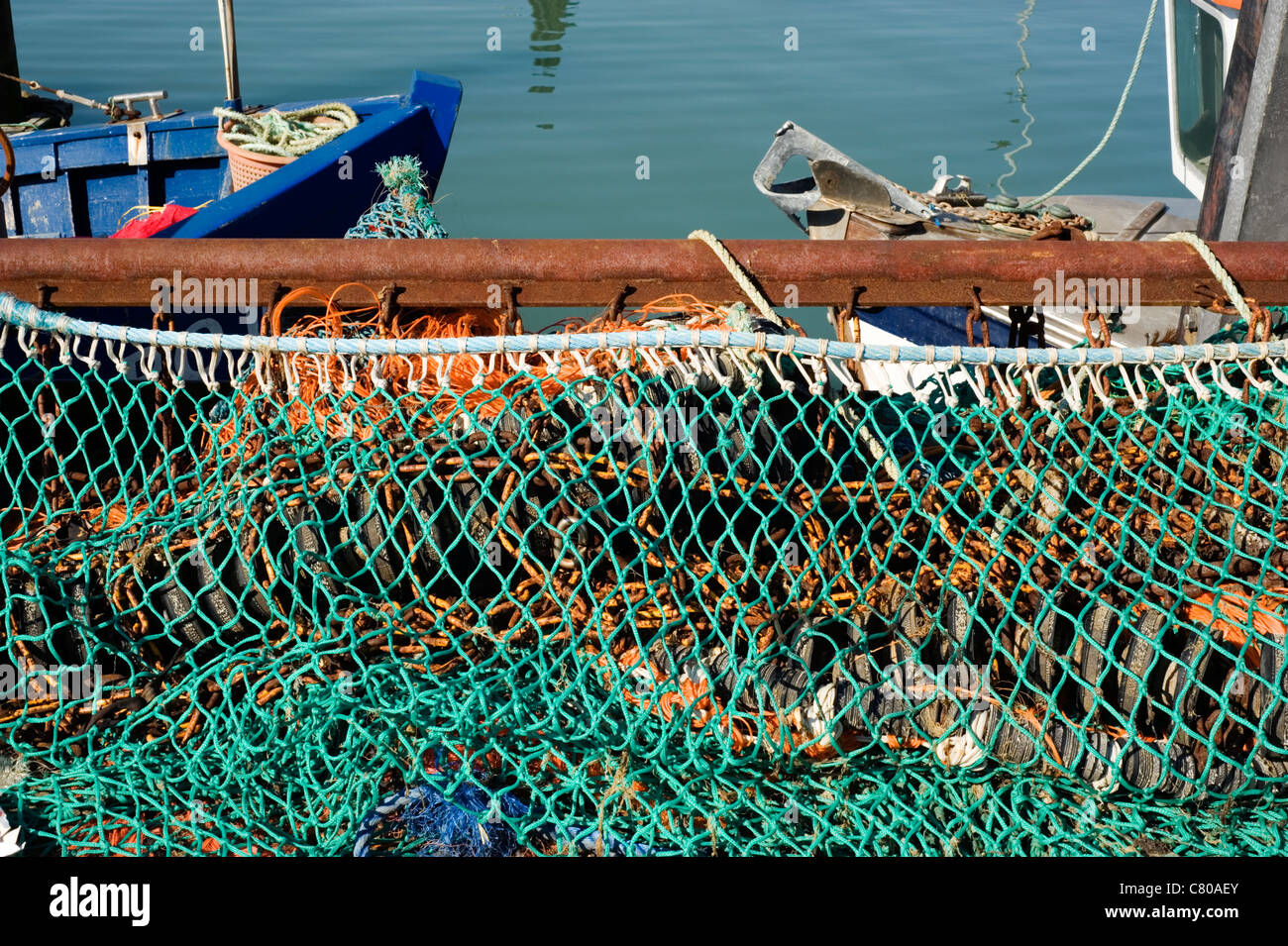 fishing nets on the ground with trawlers behind Stock Photo - Alamy