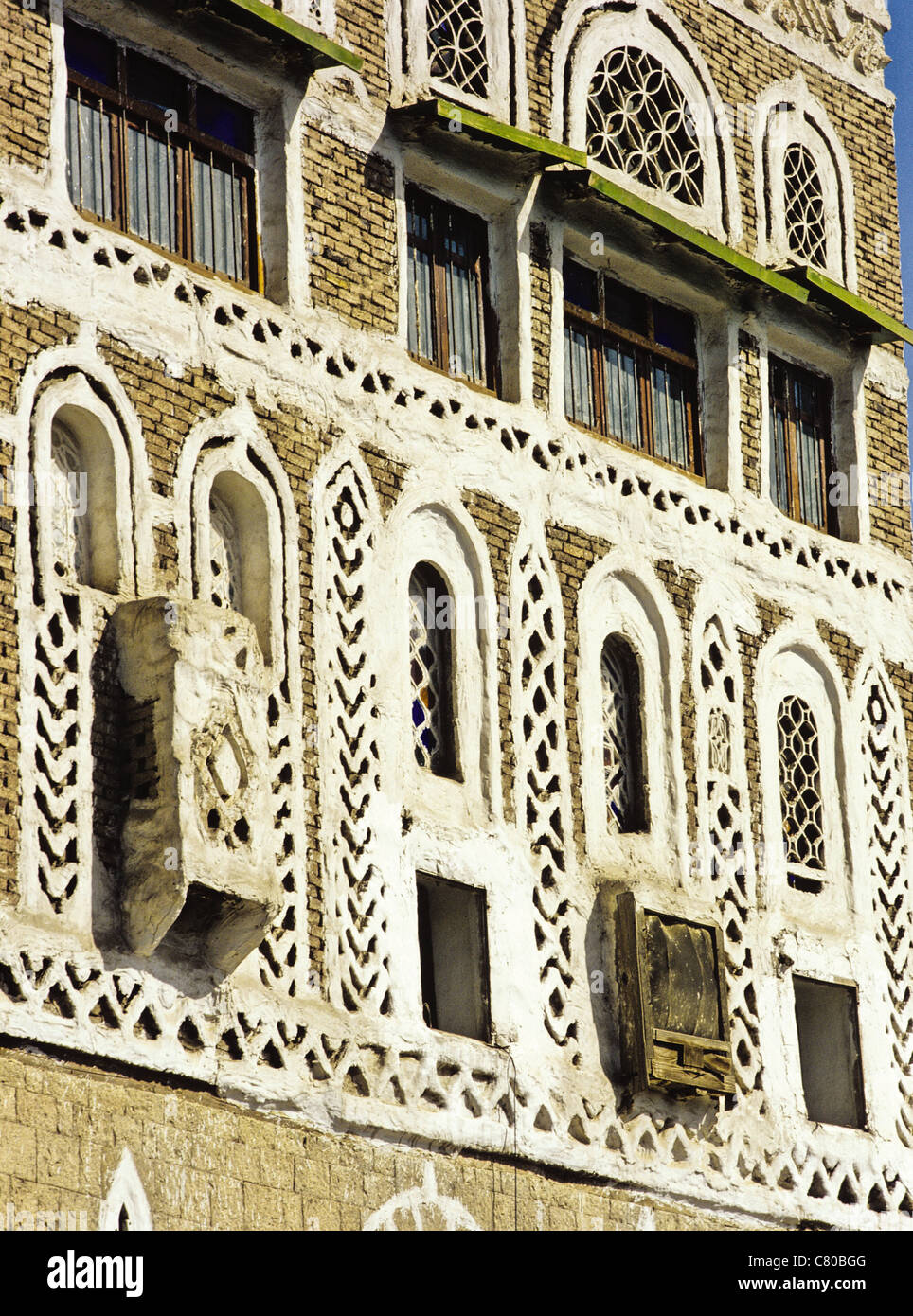 Architectural detail showing tracery windows of a multistory dwelling ...