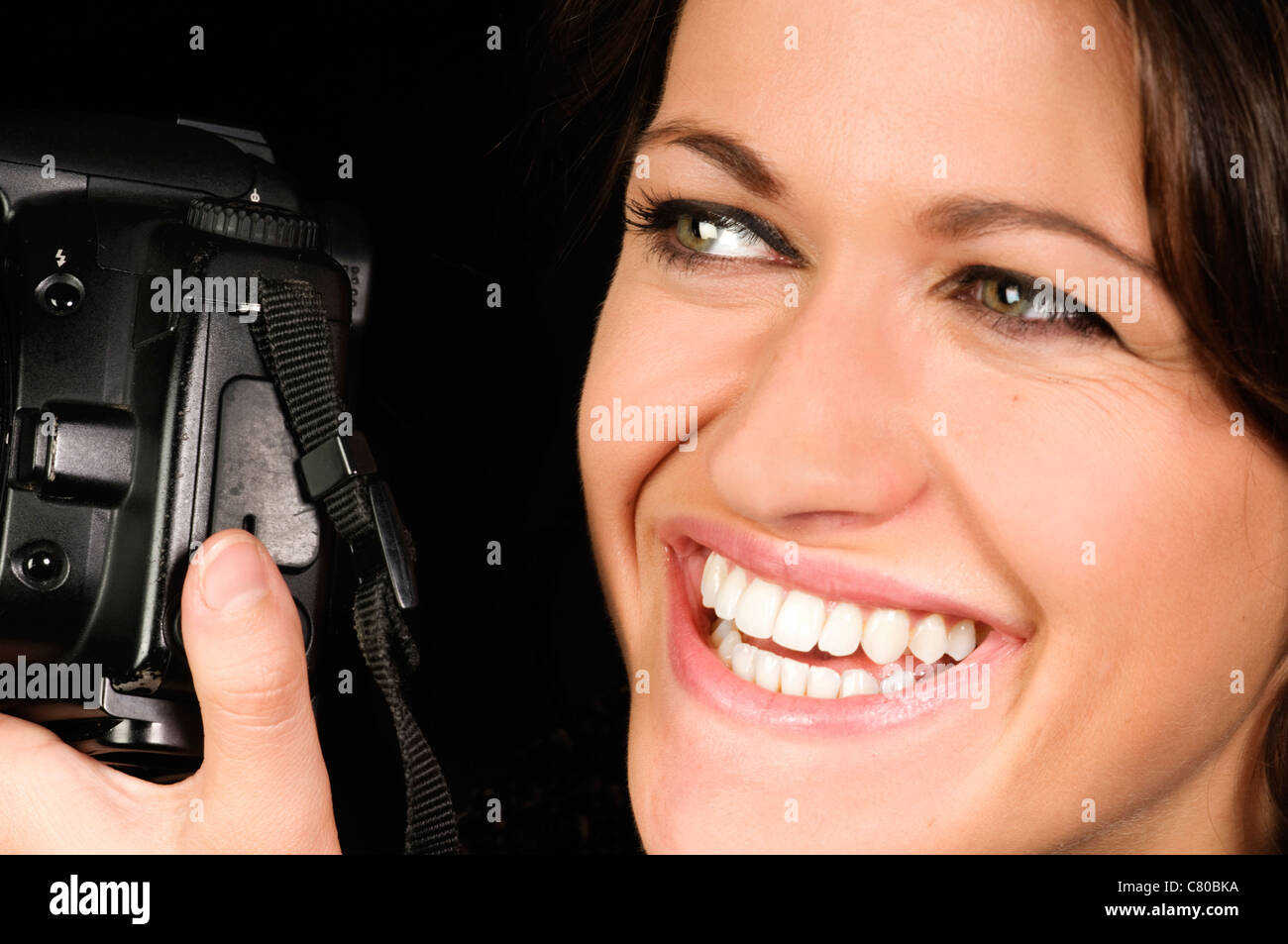 Dramatic close-up of female photographer/photojournalist Stock Photo ...