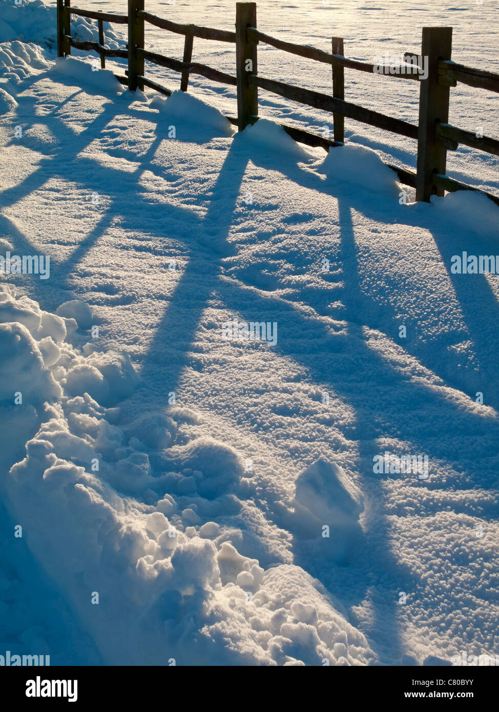 Shadow of fence on deep snow in the Derbyshire Peak District England UK ...