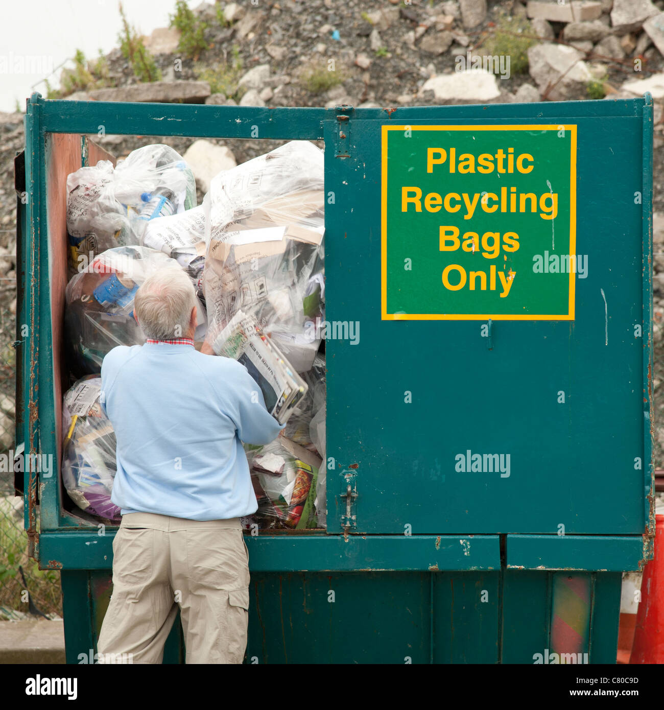 A man recycling newspapers at a civic waste transfer station UK Stock ...