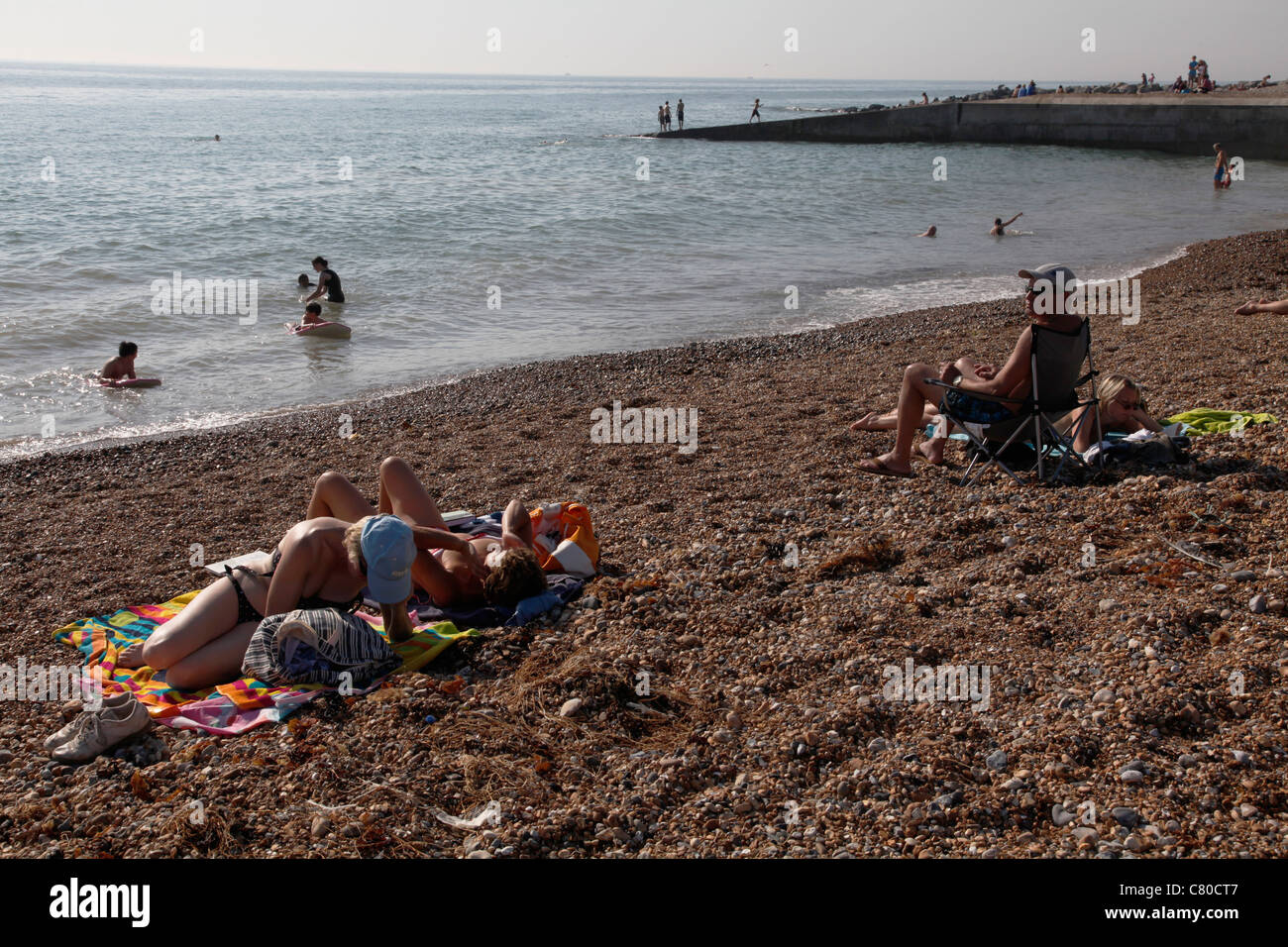 People sun bathing on the beach in Brighton, England, UK Stock Photo ...