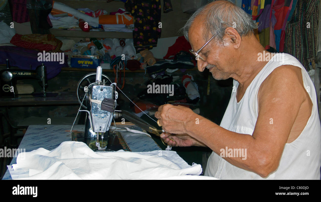 Indian tailor at treadle sewing machine in shop Pushkar Rajasthan India ...