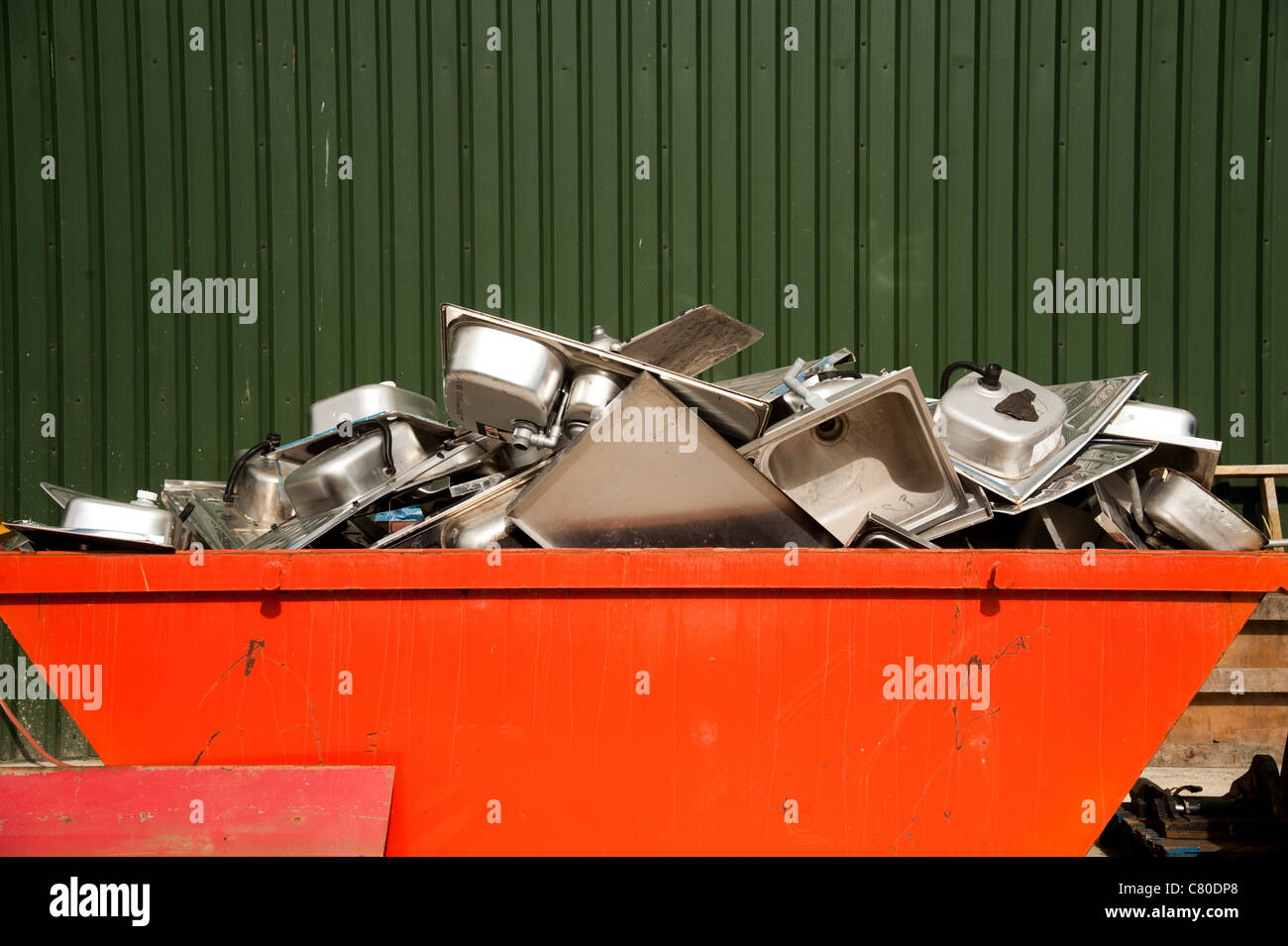 a skip full of stainless steel kitchen sinks at a recycling centre UK ...