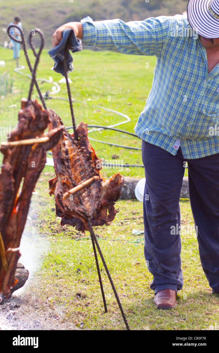 Man roasting cow meat on an improvised fire outdoor. Toca, Boyacá ...