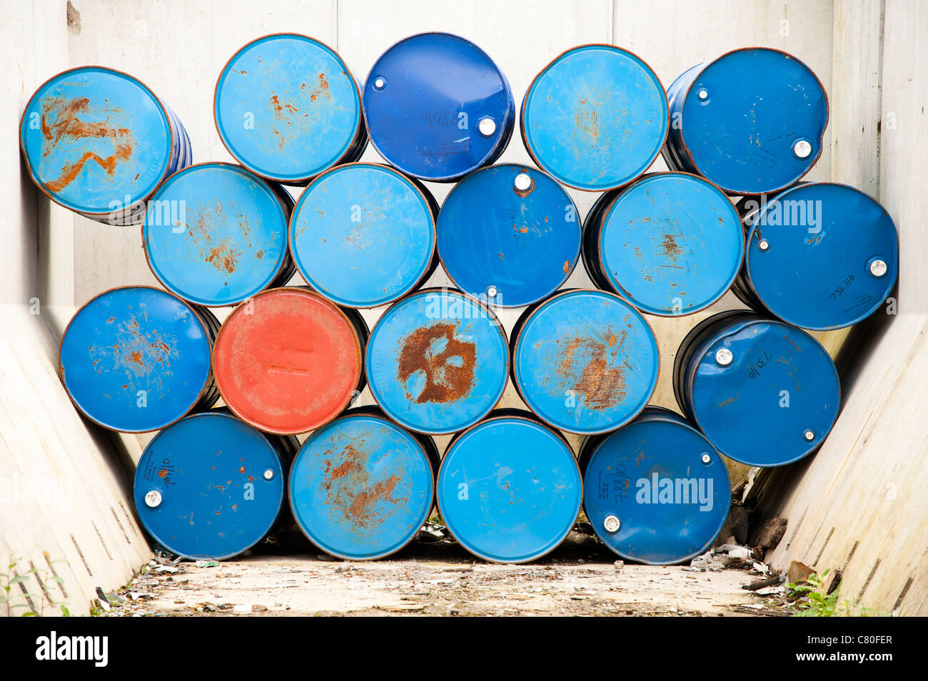 A stack of blue barrels at a recycling yard UK Stock Photo - Alamy
