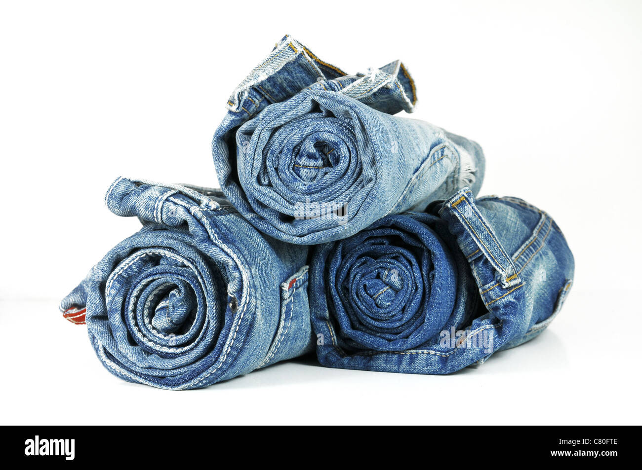 Three rolled up blue denim jeans isolated on white background Stock ...