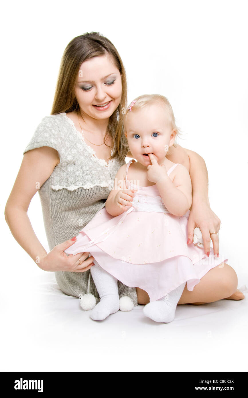 Young and beautiful mother with her sweet little daughter isolated on ...