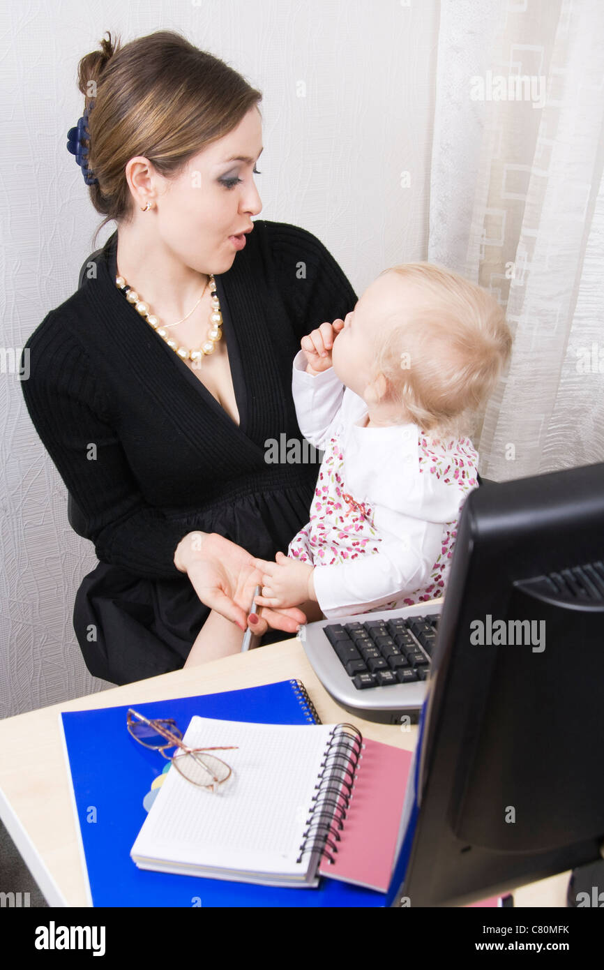 busy mother holding her baby Stock Photo - Alamy