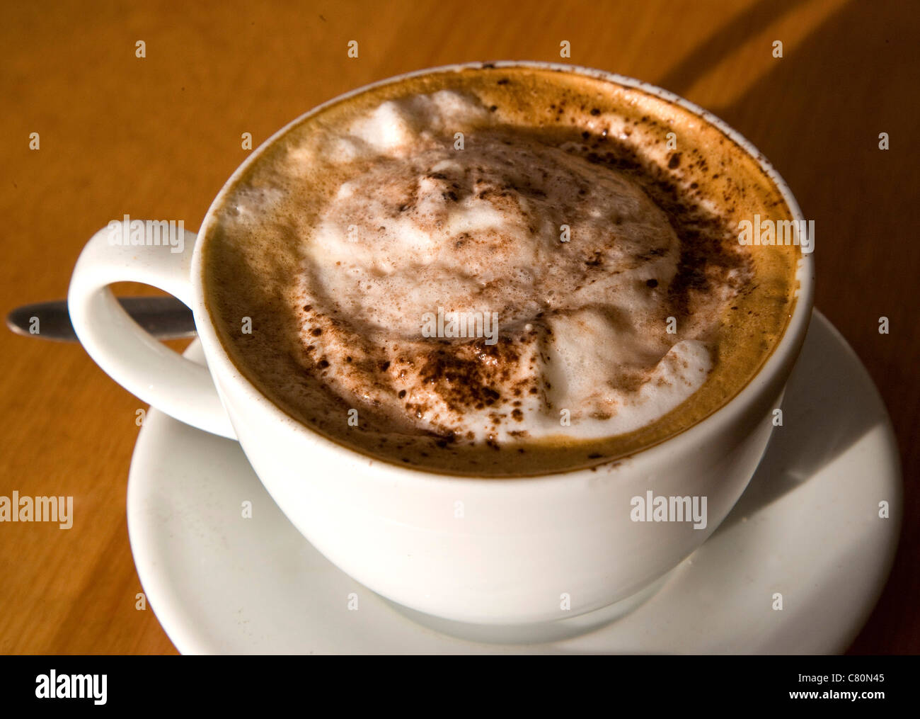 A cup of cappuccino coffee in a café restaurant Stock Photo - Alamy
