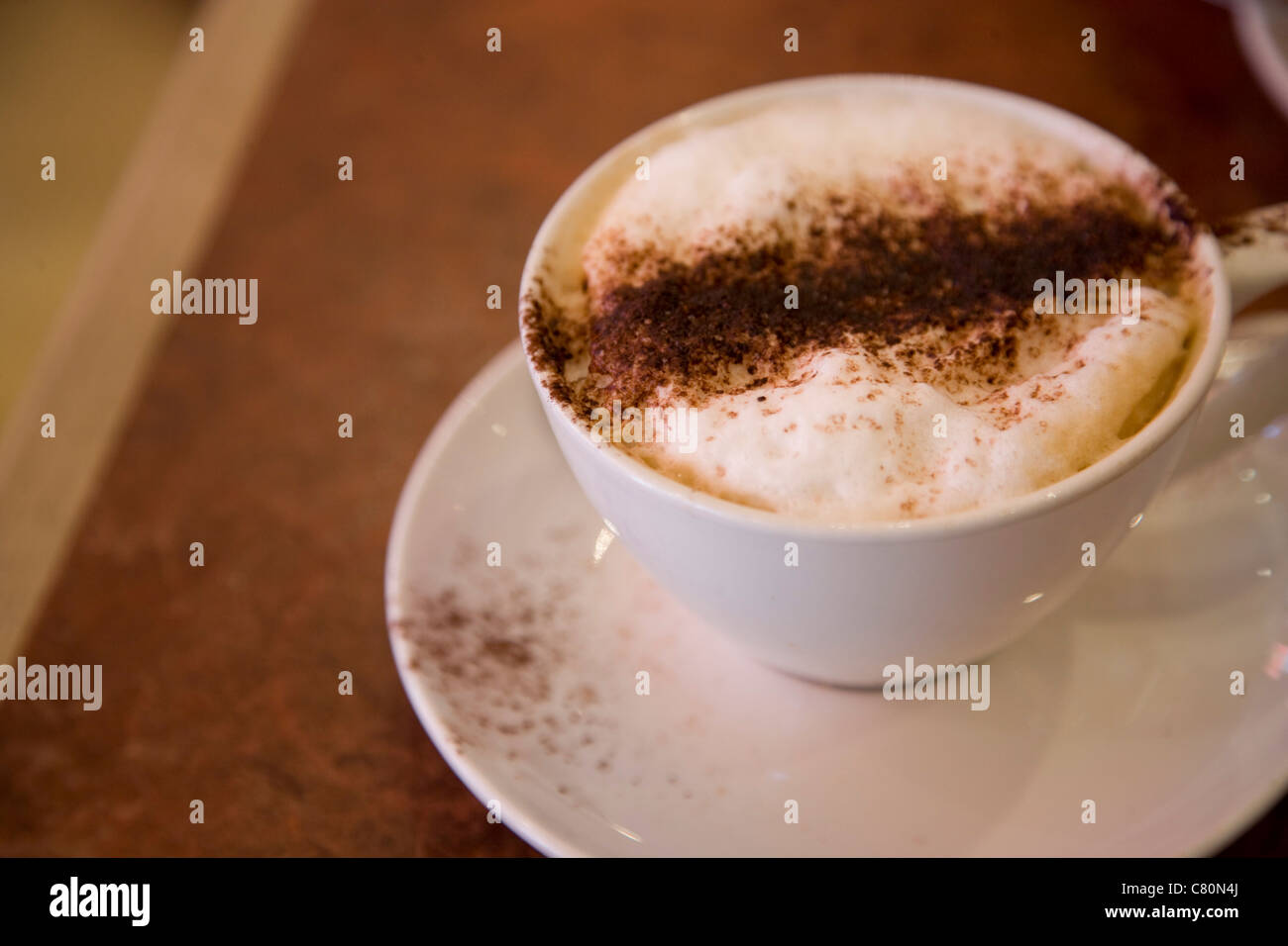 A cup of cappuccino coffee in a café restaurant Stock Photo - Alamy