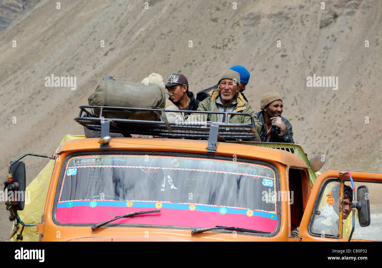Travellers arrive on the roof of a fully loaded vehicle at Rangdom ...