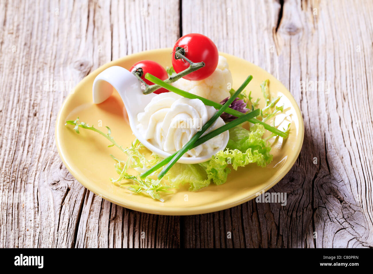 Swirl of cream cheese and vegetable garnish Stock Photo - Alamy