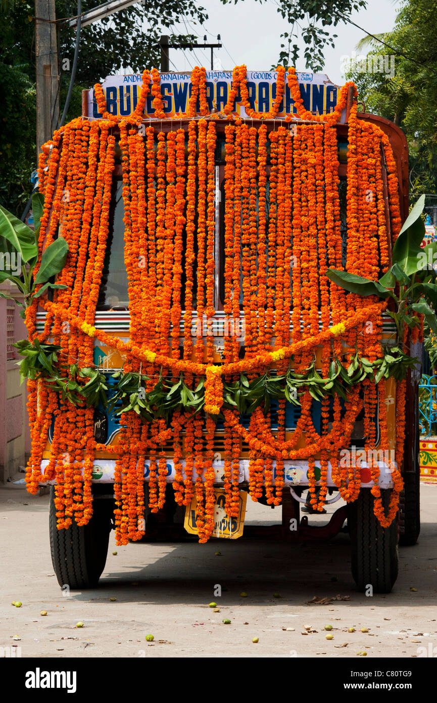Indian lorry covered in flower garlands during the Hindu festival of ...