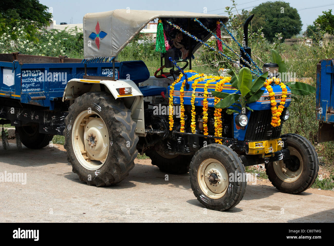 Indian tractor covered in flower garlands during the Hindu festival of ...