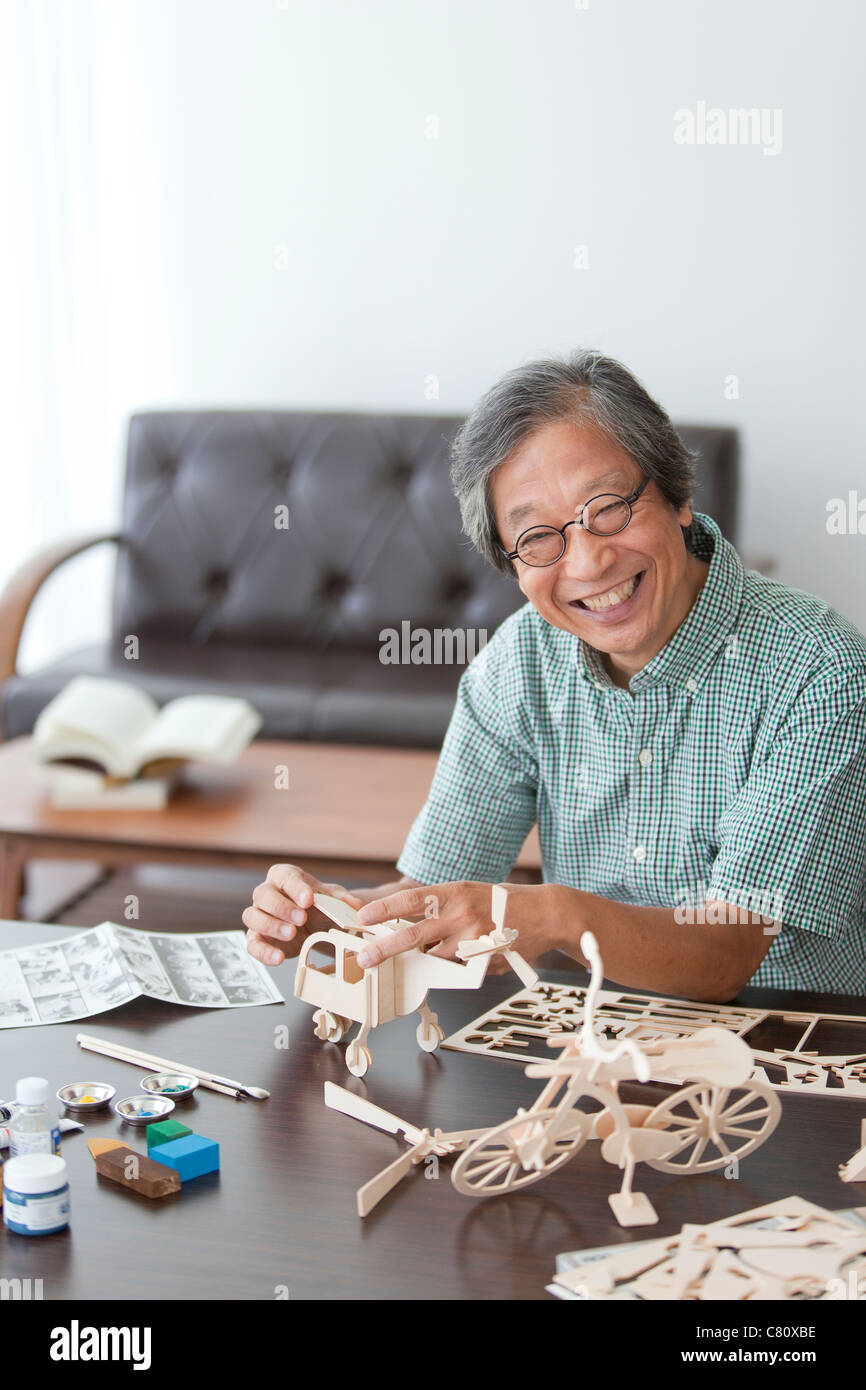Senior Man Building Wooden Models Stock Photo - Alamy