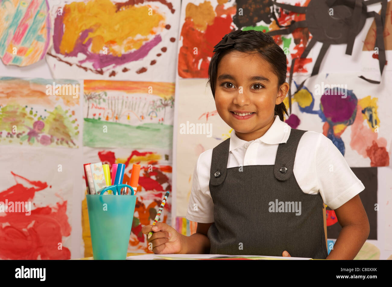 A young school girl smiling Stock Photo - Alamy