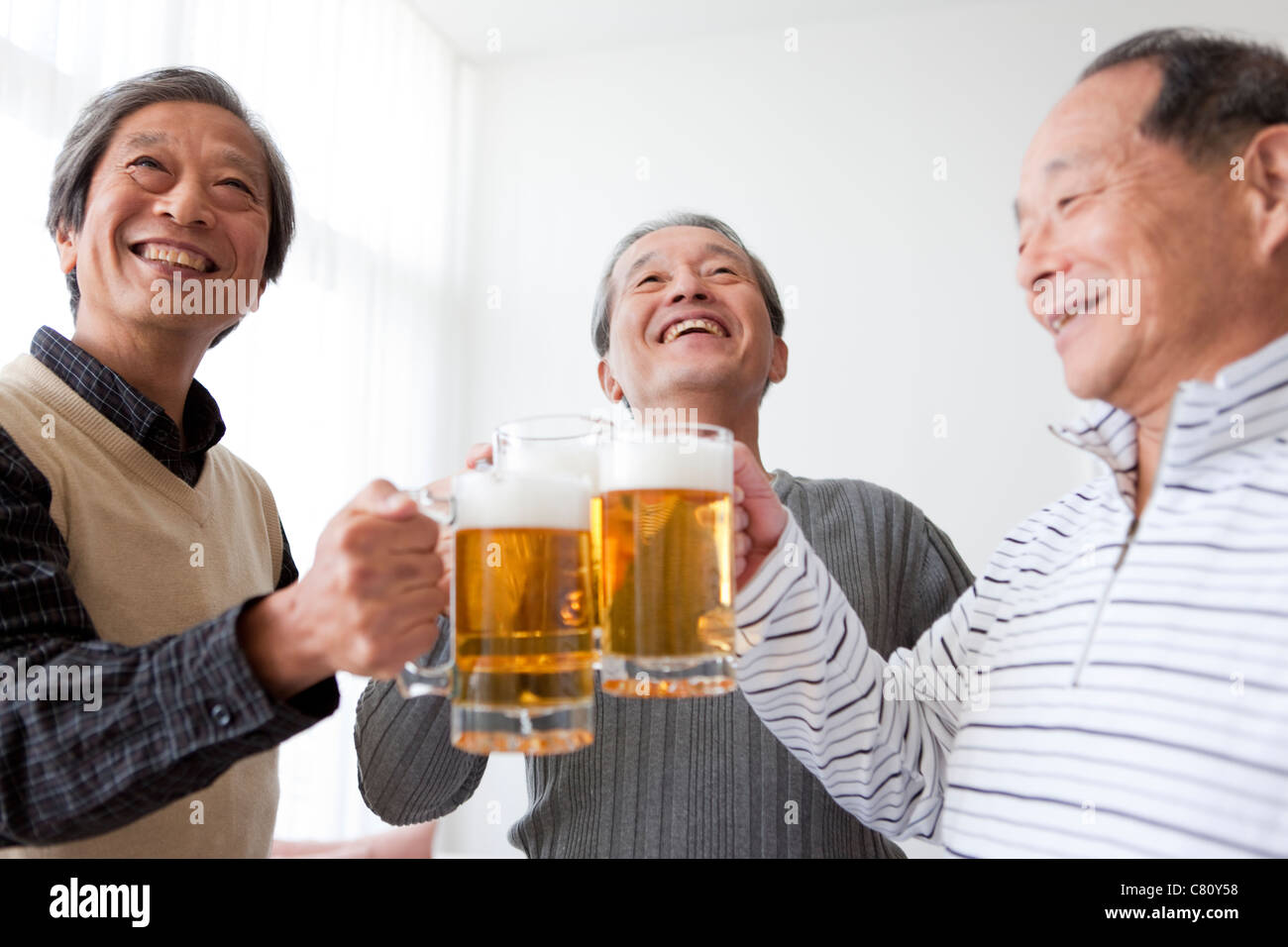 Three Senior Men Toasting with Pint Stock Photo - Alamy