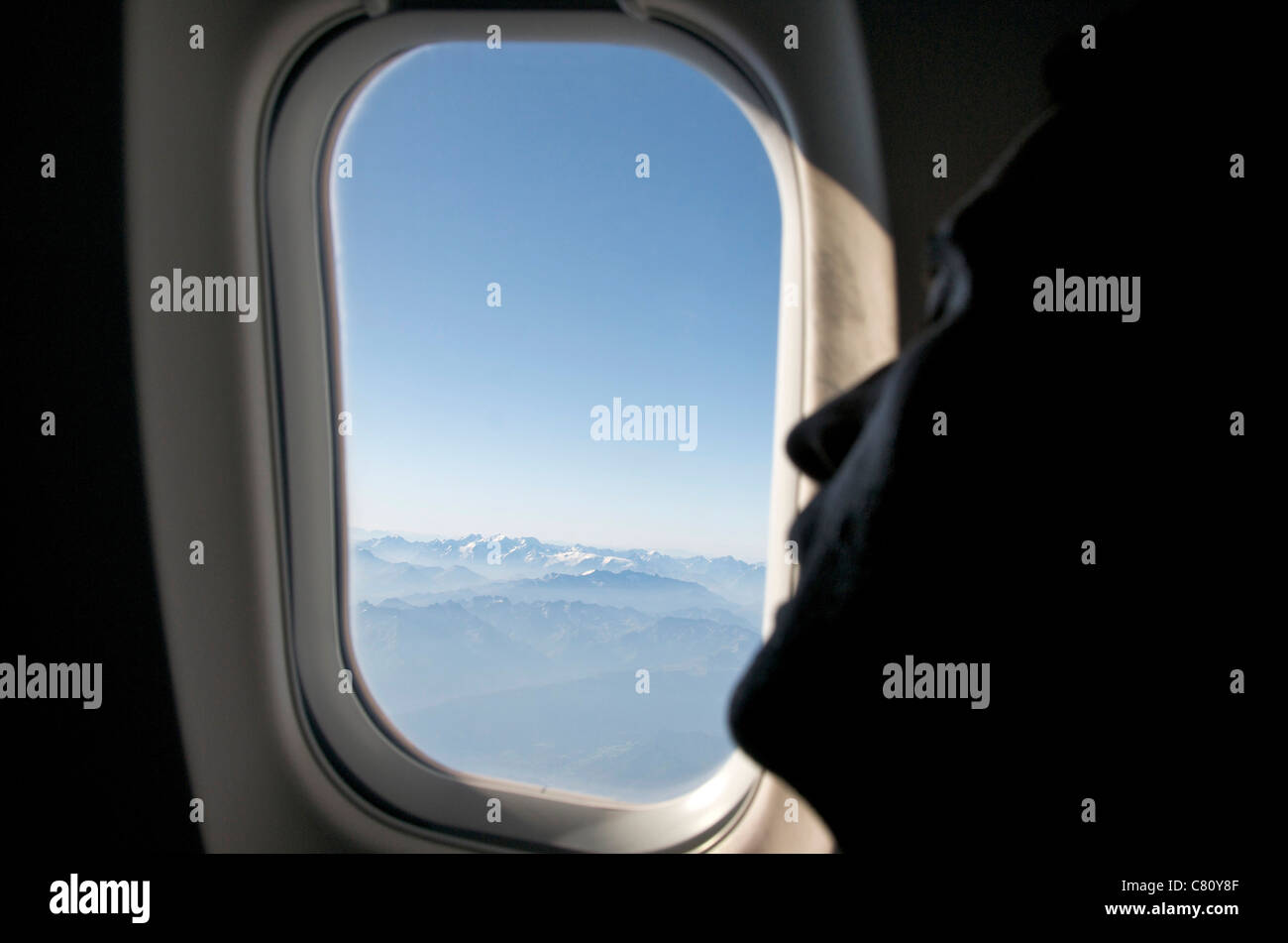 Man looking out of an airplane window Stock Photo - Alamy