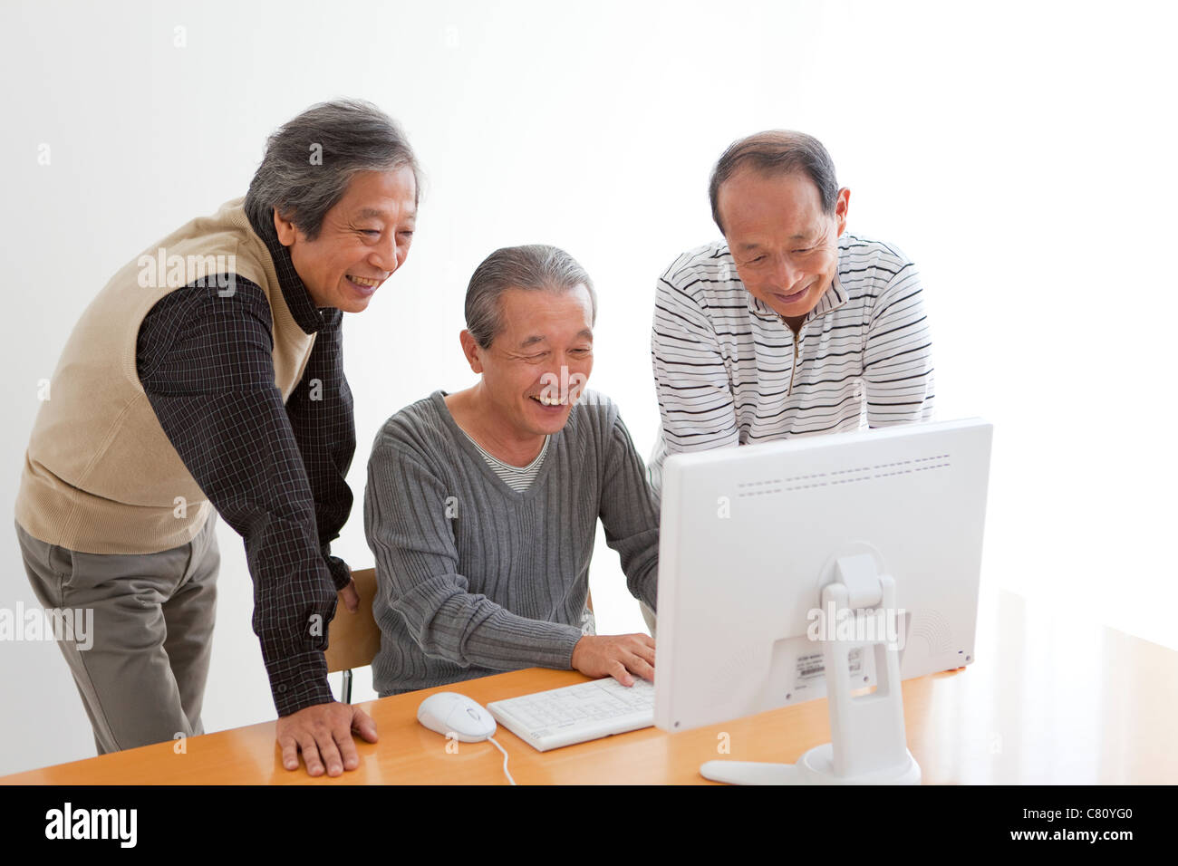 Senior Three Men at Computer Stock Photo - Alamy