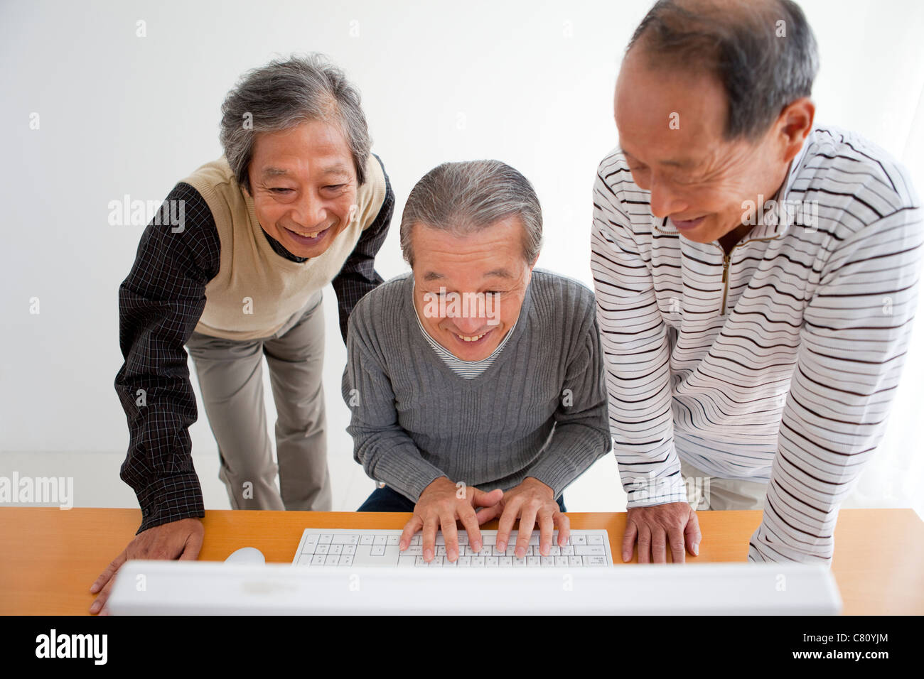 Senior Three Men at Computer Stock Photo - Alamy