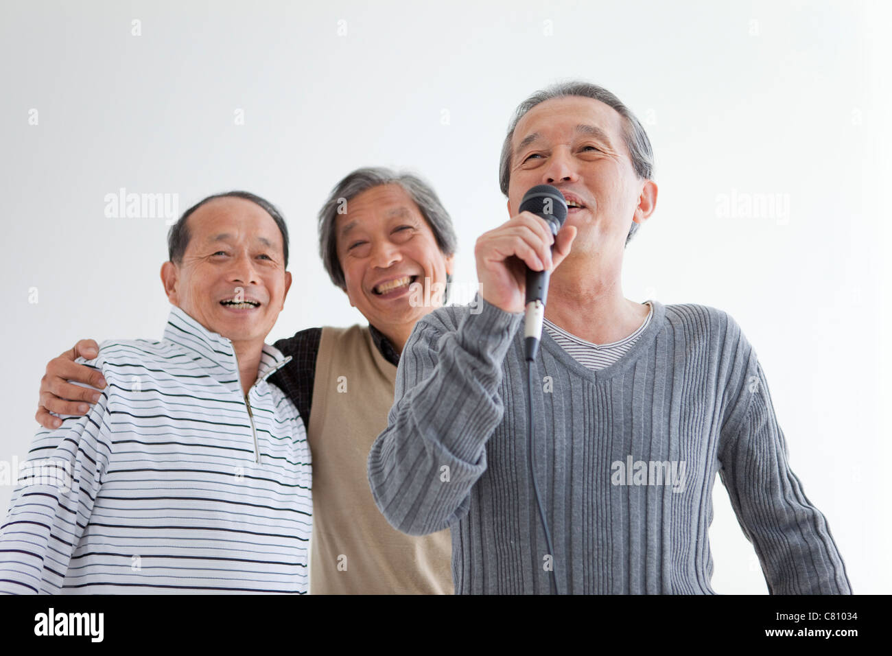 Three Senior Men Singing Karaoke Stock Photo - Alamy