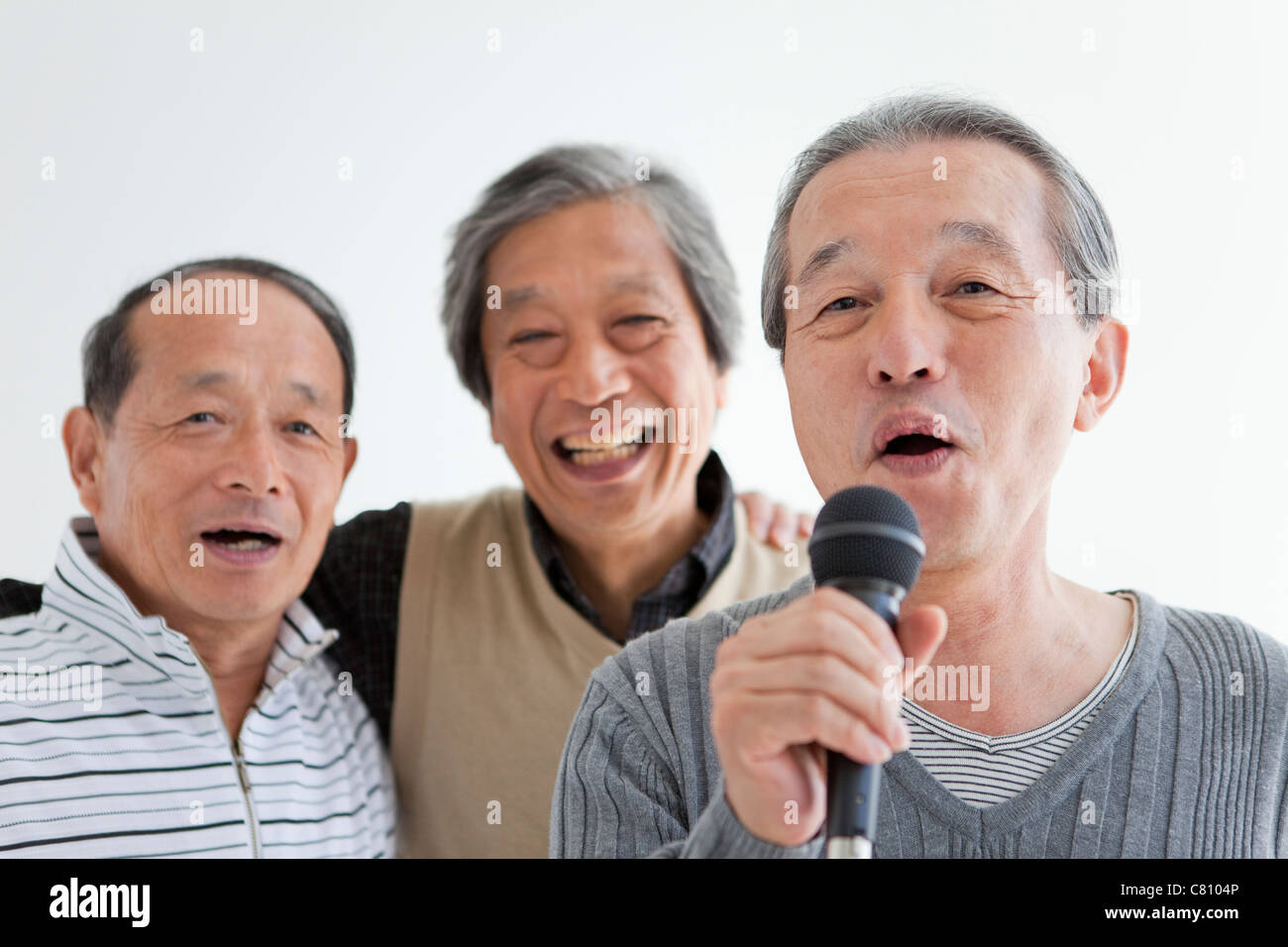 Three Senior Men Singing Karaoke Stock Photo - Alamy