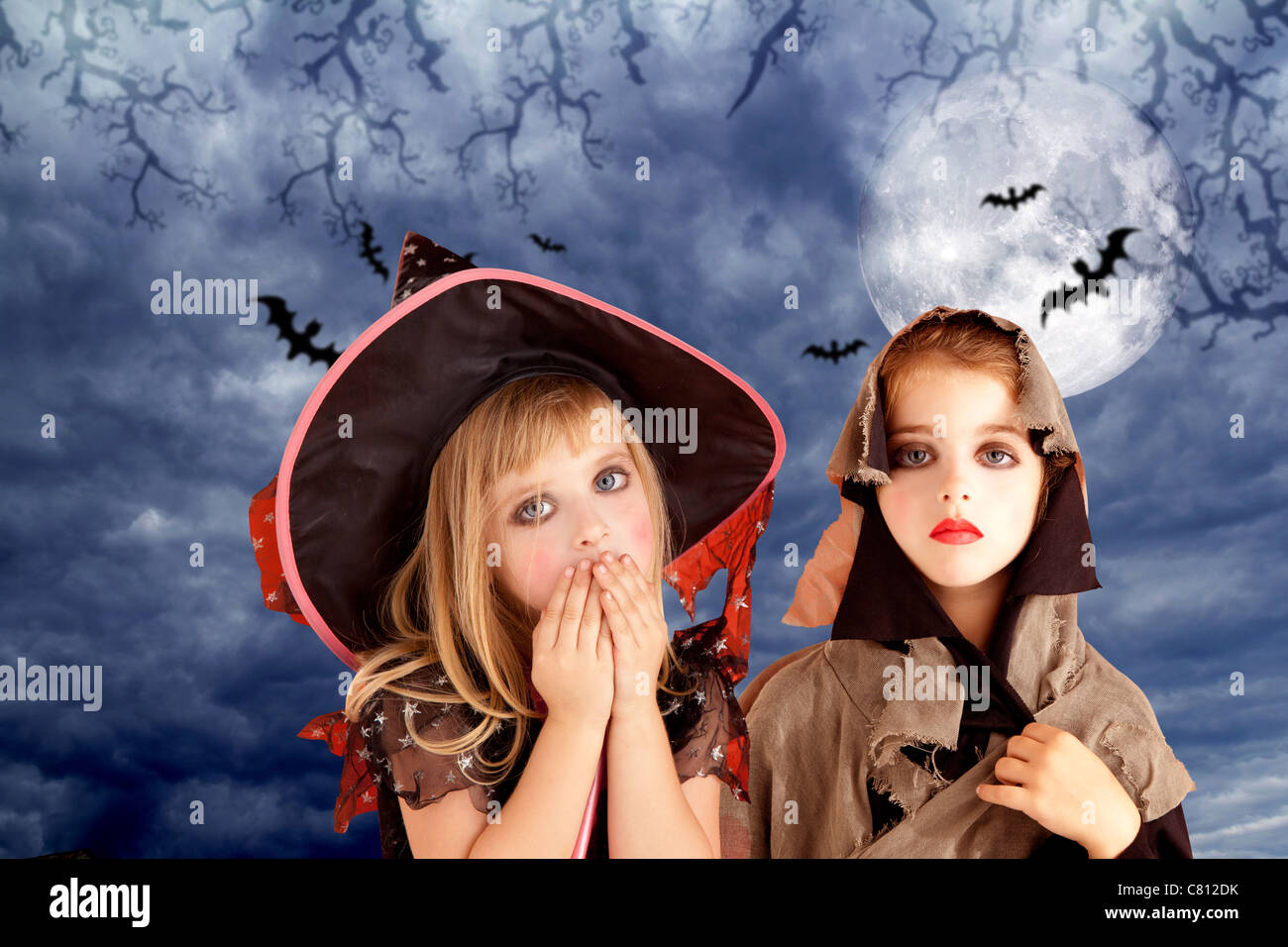halloween costumes kid girls on moon night sky with bats Stock Photo ...