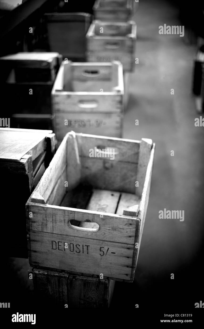 Old bushel boxes for storing fruit are lined up in the packing area of ...