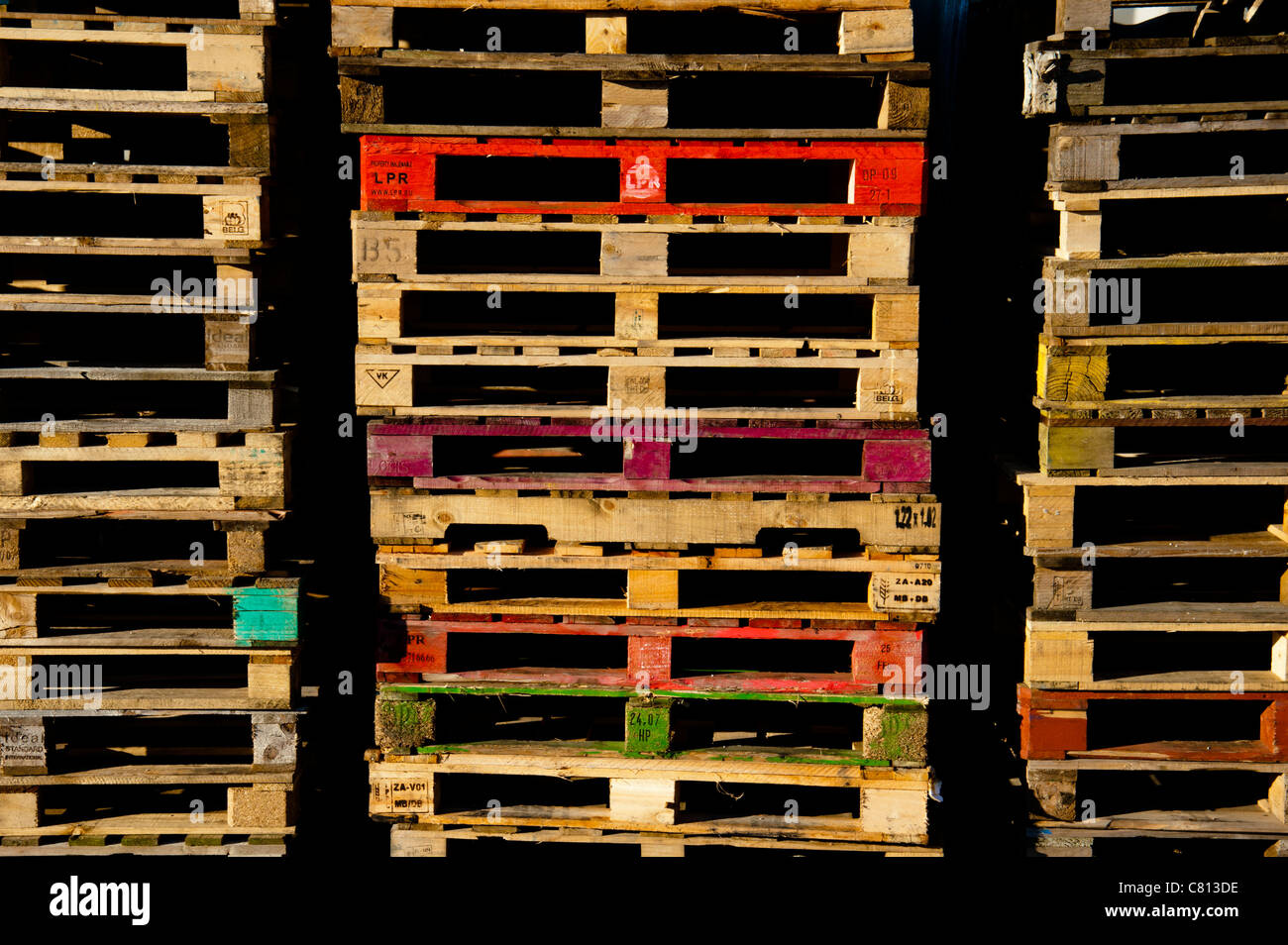 Stacked pallets close up forming interesting and colourful patterns ...