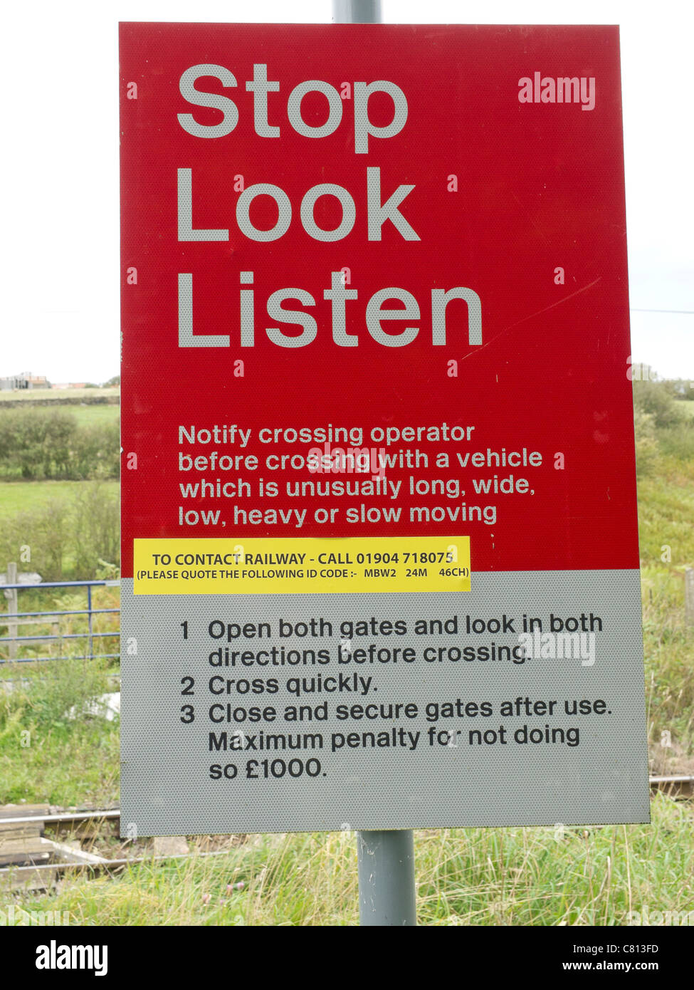 Unmanned level crossing sign Stop Look Listen on a rural branch line ...