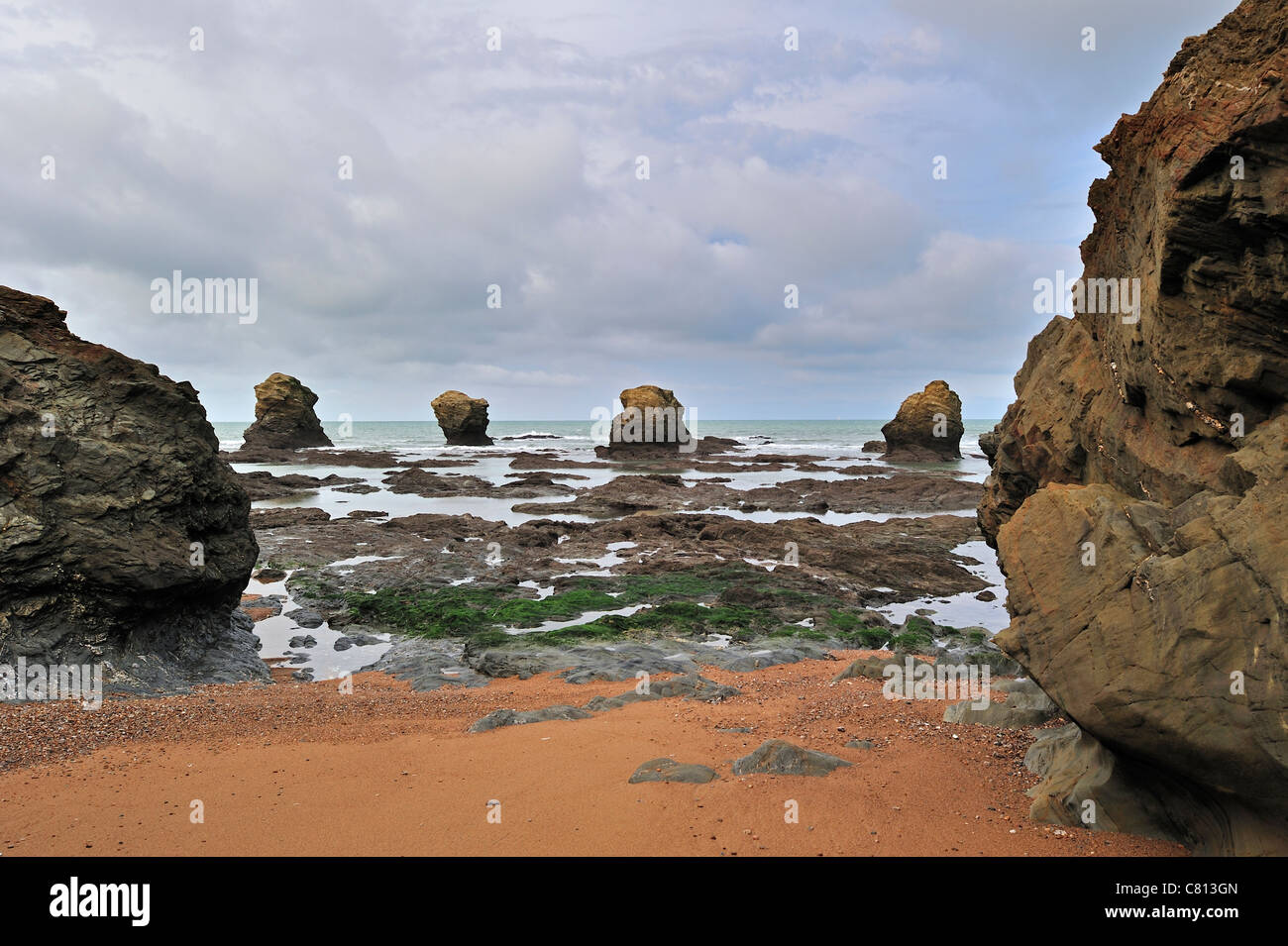 Eroded sea stacks at the Plage des Cinq Pineaux at low tide, Saint ...