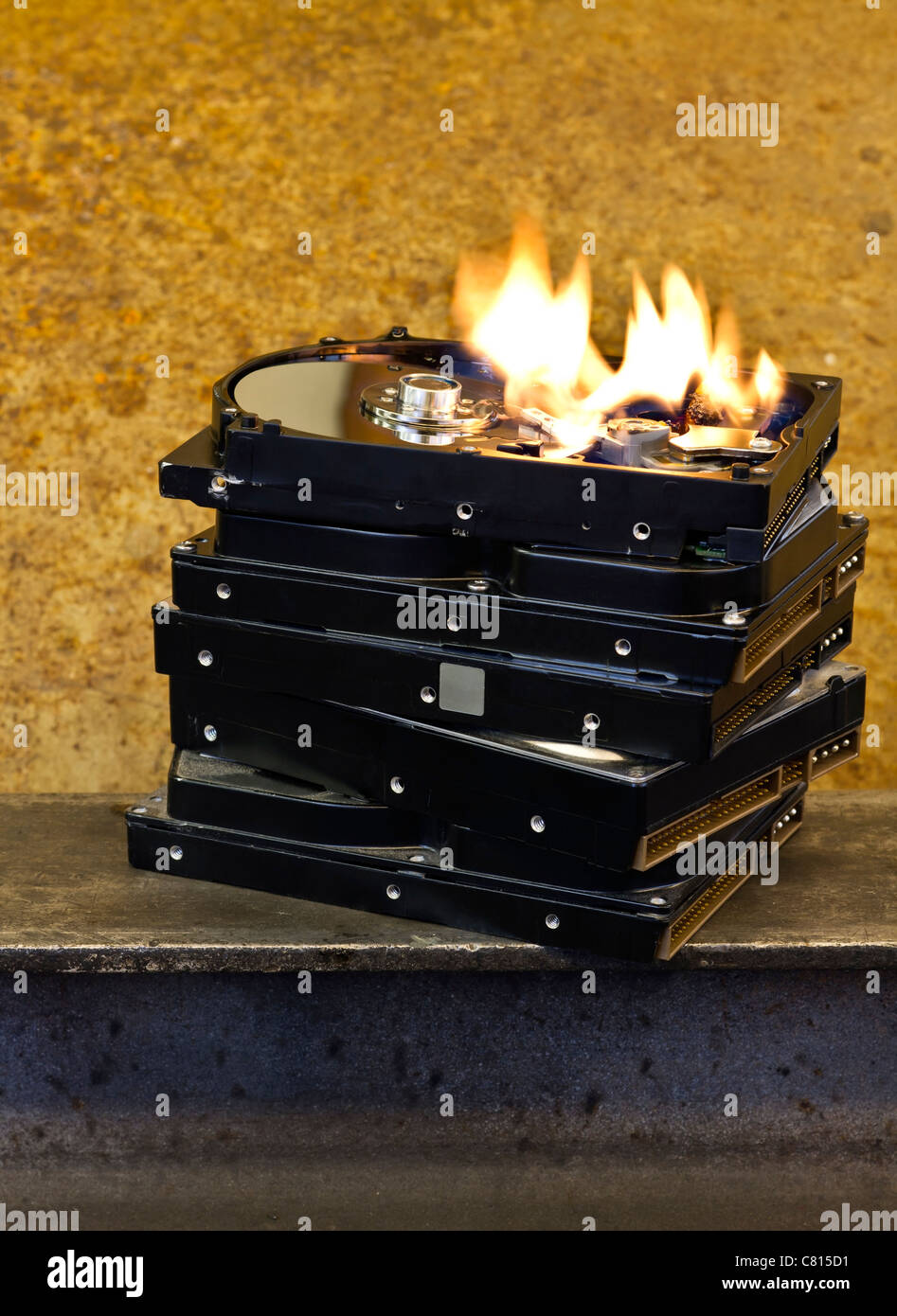burning stack of hard disks in front of rusty back Stock Photo - Alamy
