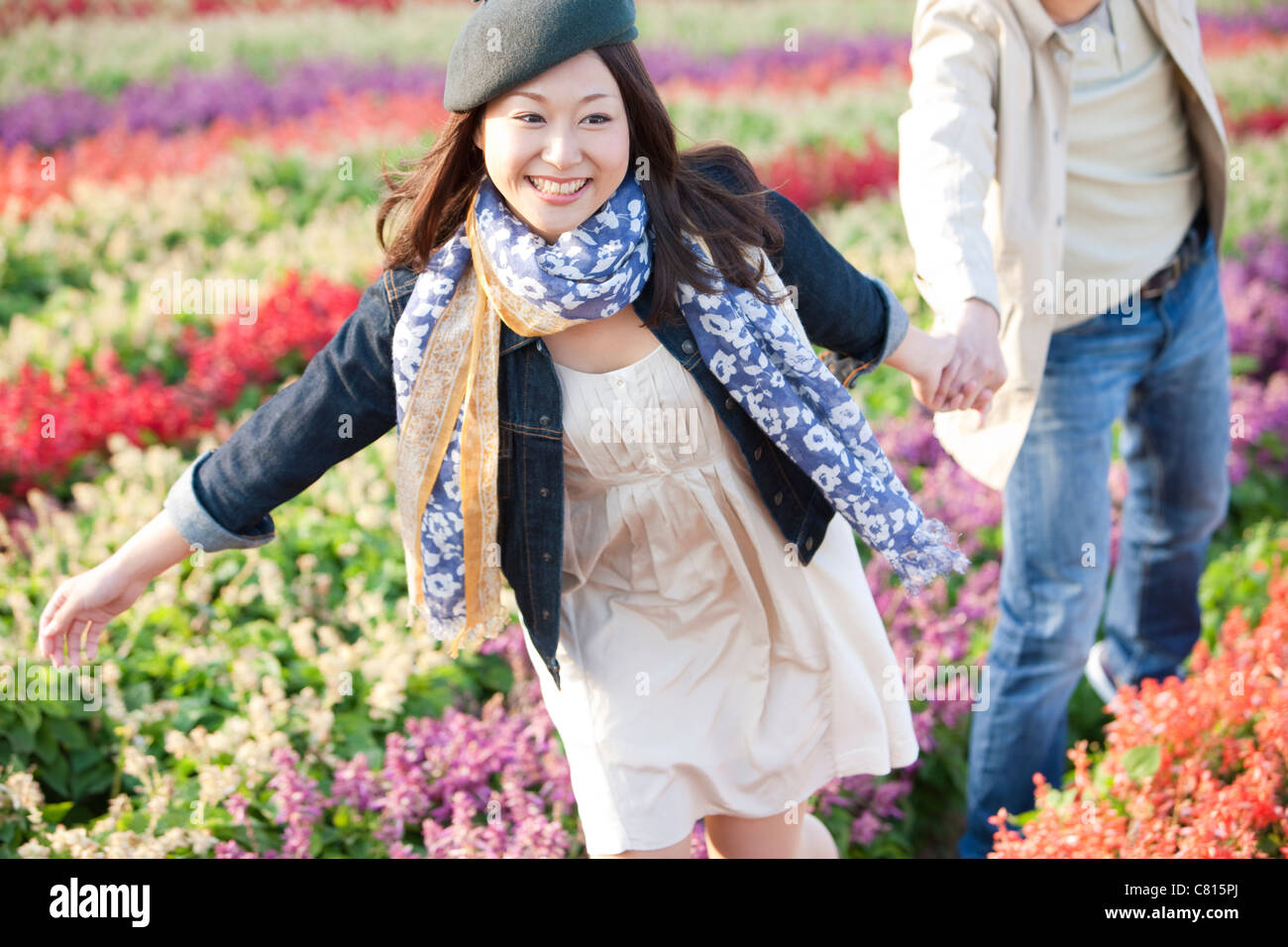 Couple Walking in Flower Field Stock Photo - Alamy